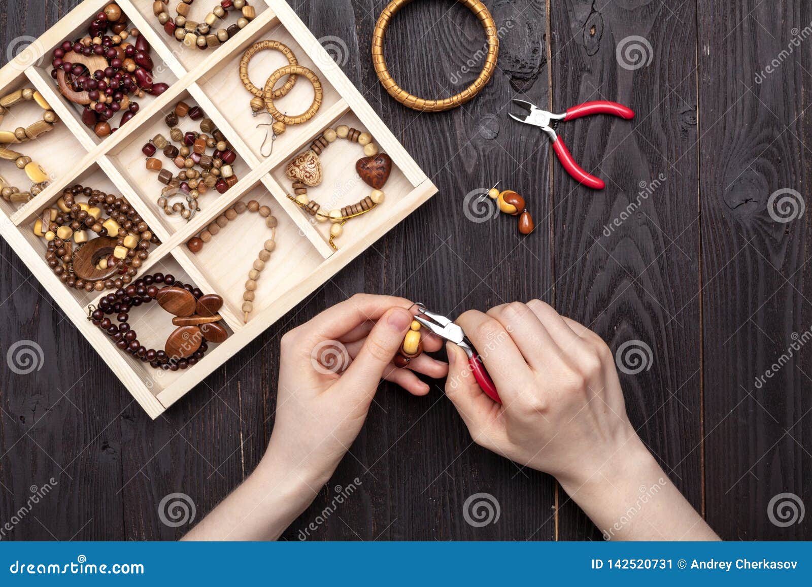 Handwork at Home, the Girl Makes Jewelry Hands on the Table Stock Image ...