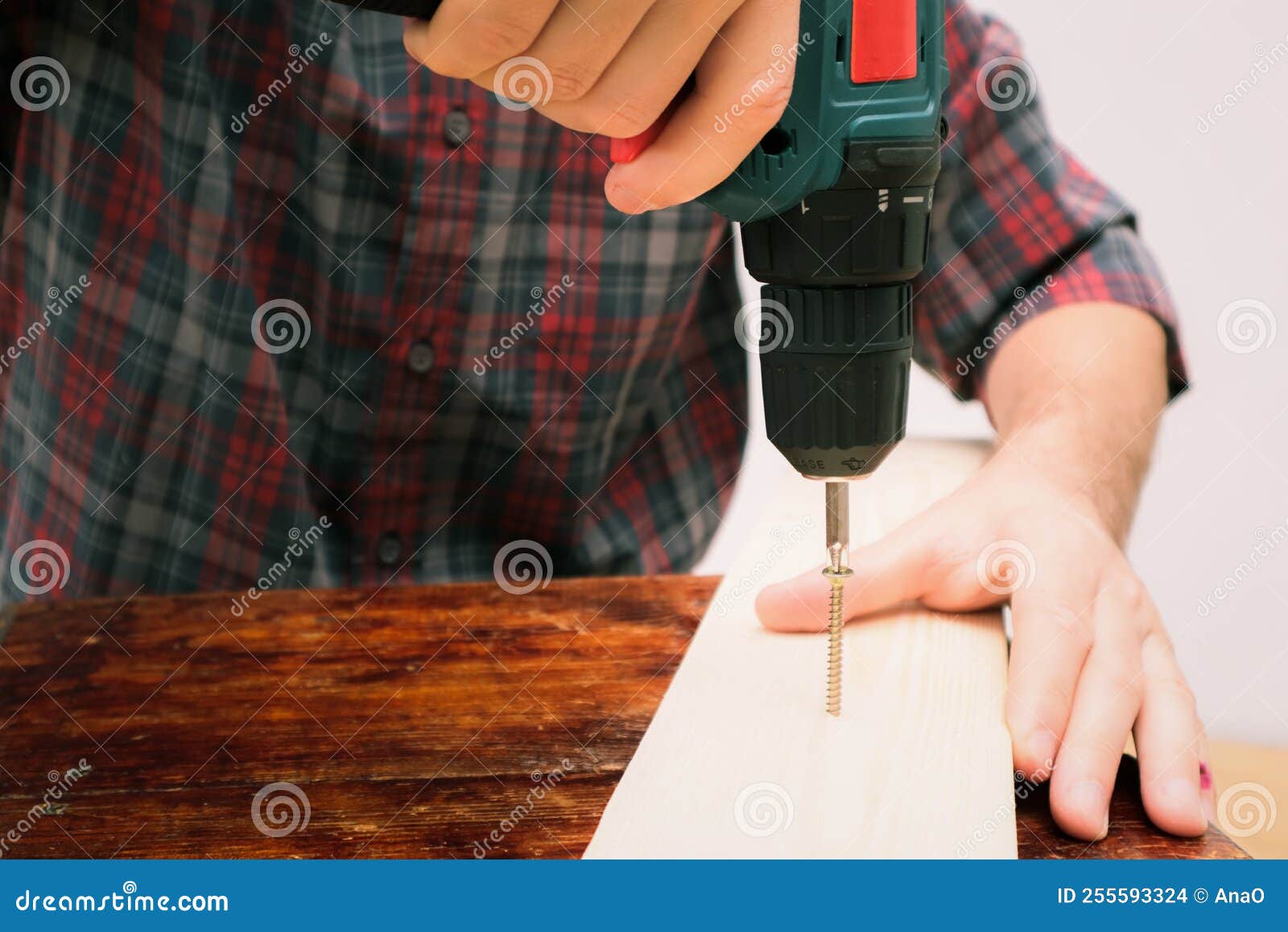 Handworker Working with an Electric Screwdriver. Carpenter Fixing ...