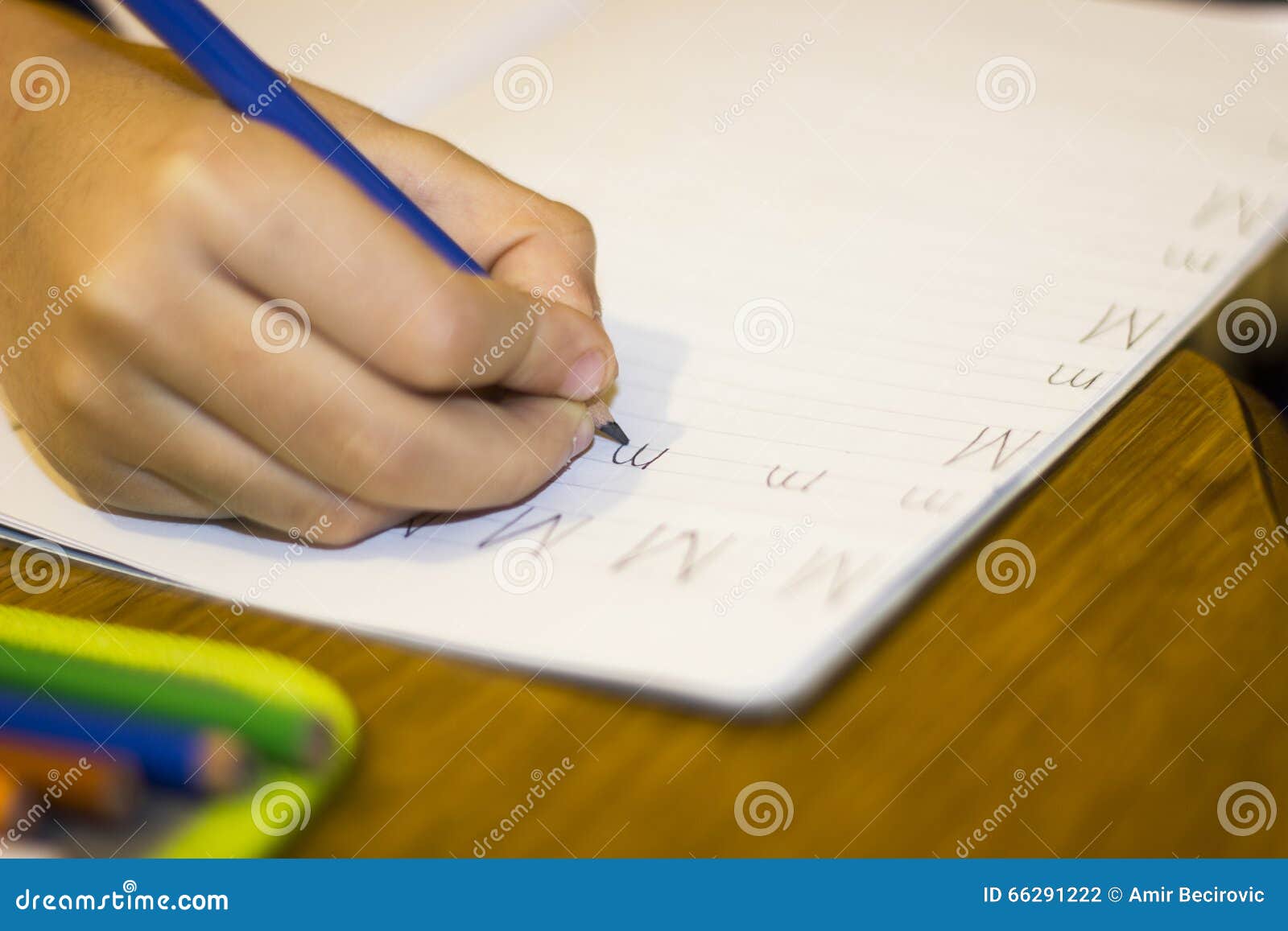 The Child Writes the Letter M by Hand Stock Photo - Image of hand, blue ...