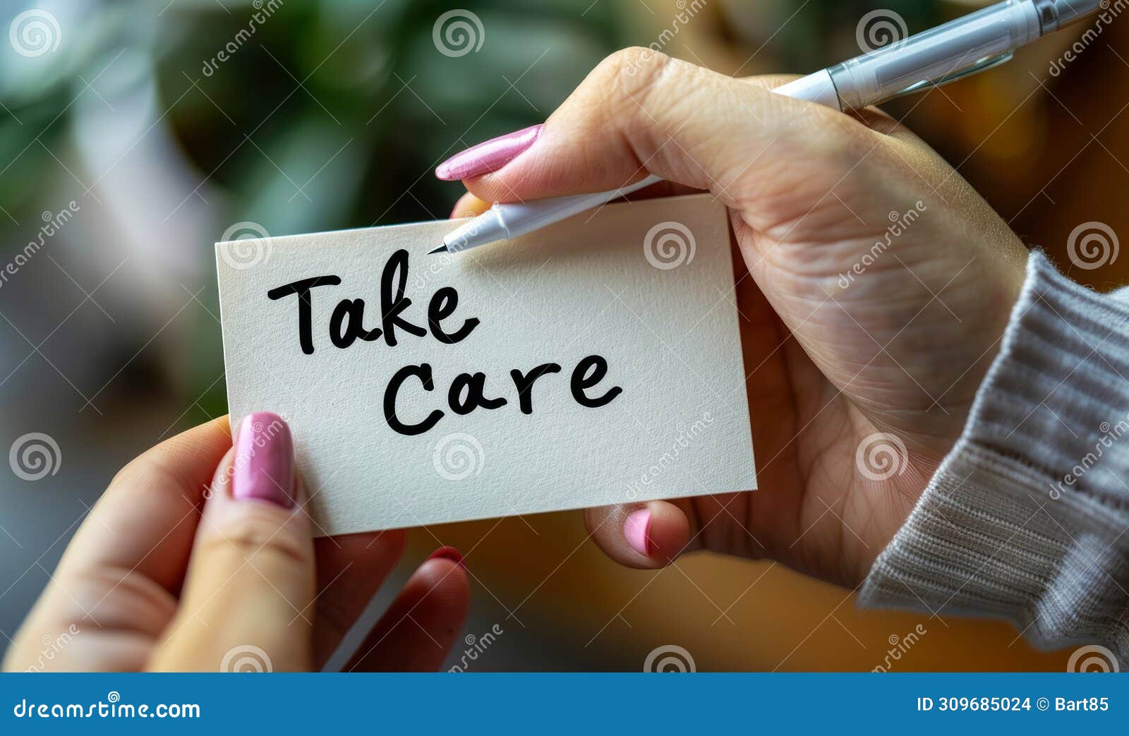 Handwriting a Heartfelt Take Care Message on a Plain White Card, a ...