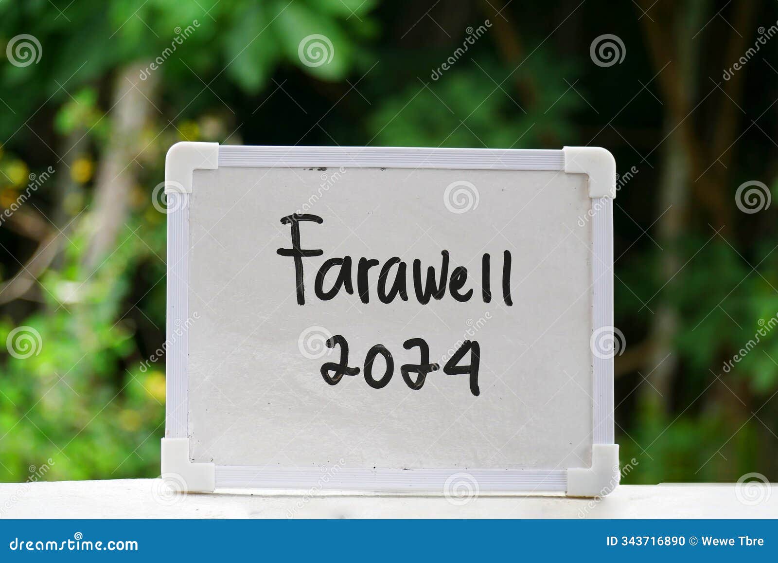 Handwritten Text "Farewell 2024" on White Chalkboard with Blurred ...