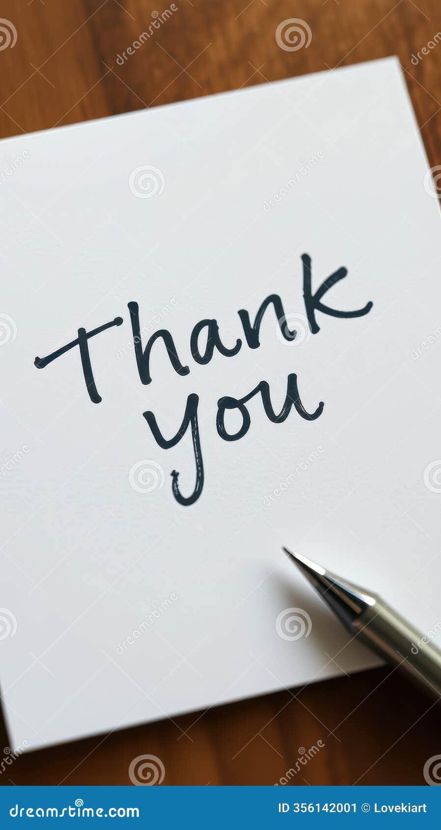 Handwritten Thank You Note on a Notepad with a Silver Pen on a Wooden ...