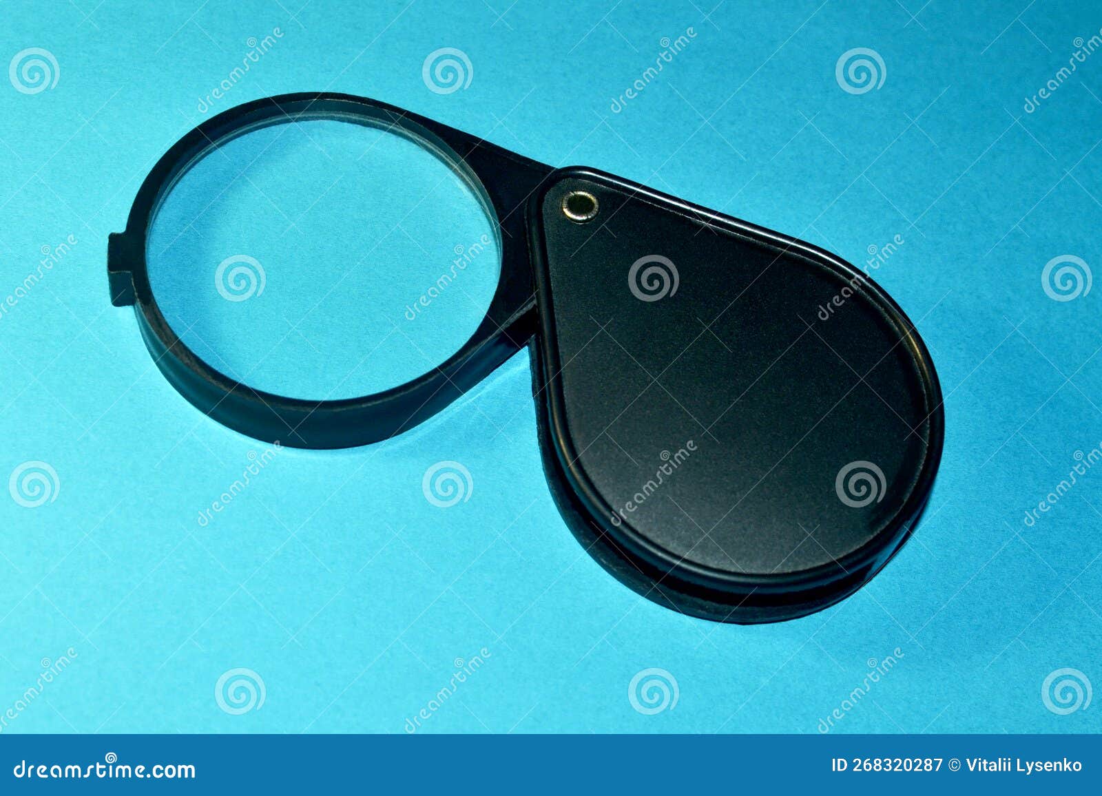 Handy Pocket Folding Magnifier on a Blue Background Stock Image - Image ...
