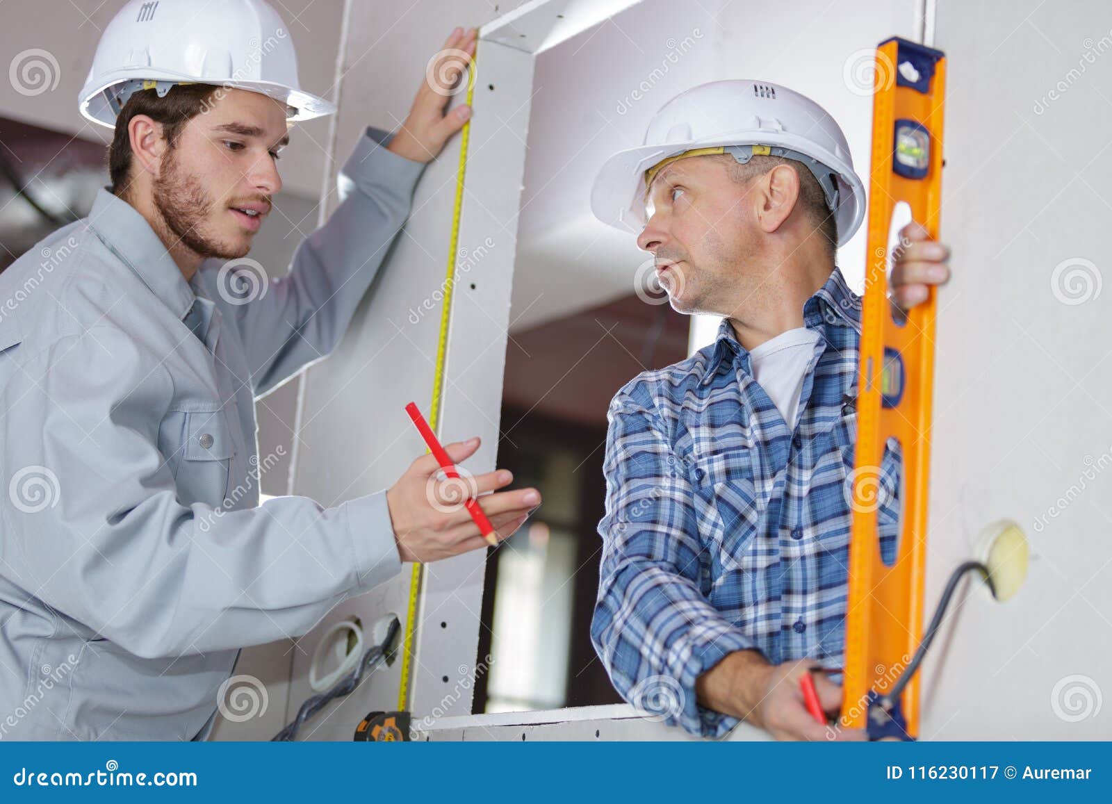 Handyman with Apprentice Working in New Home Stock Image - Image of ...