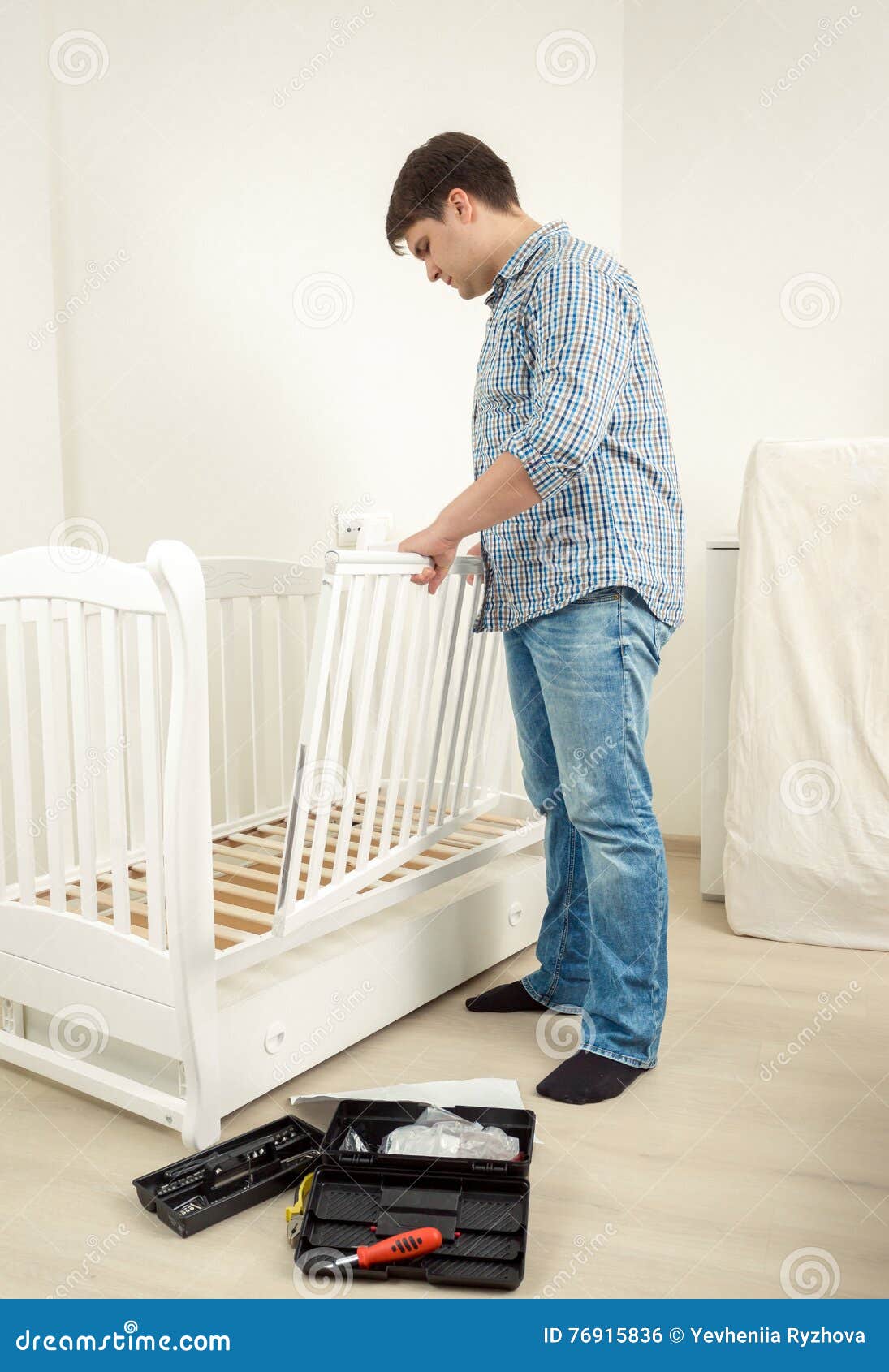 Handyman Assembling White Baby Crib in New Apartment Stock Photo ...