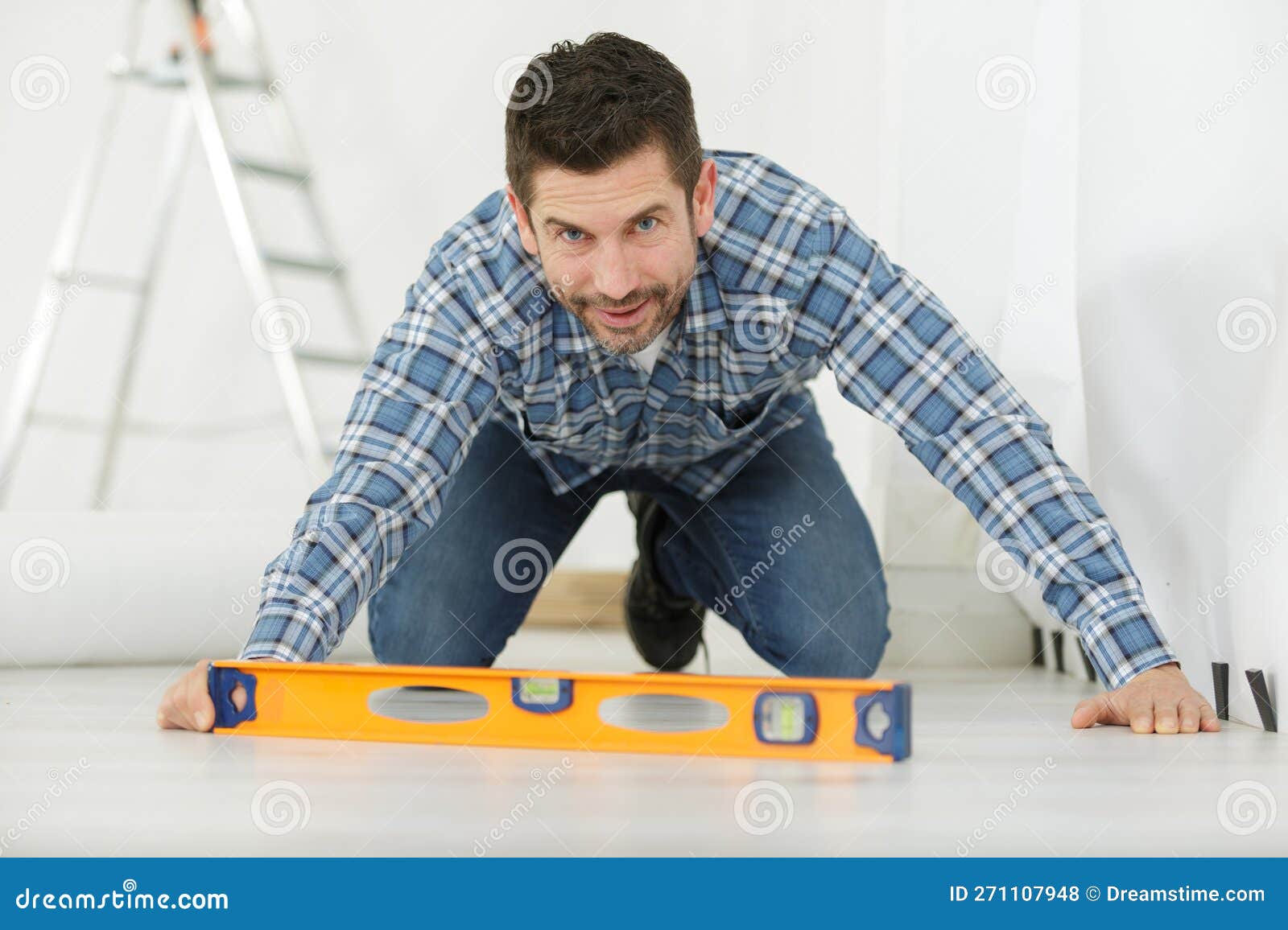 Handyman check floor level stock photo. Image of laminate - 271107948