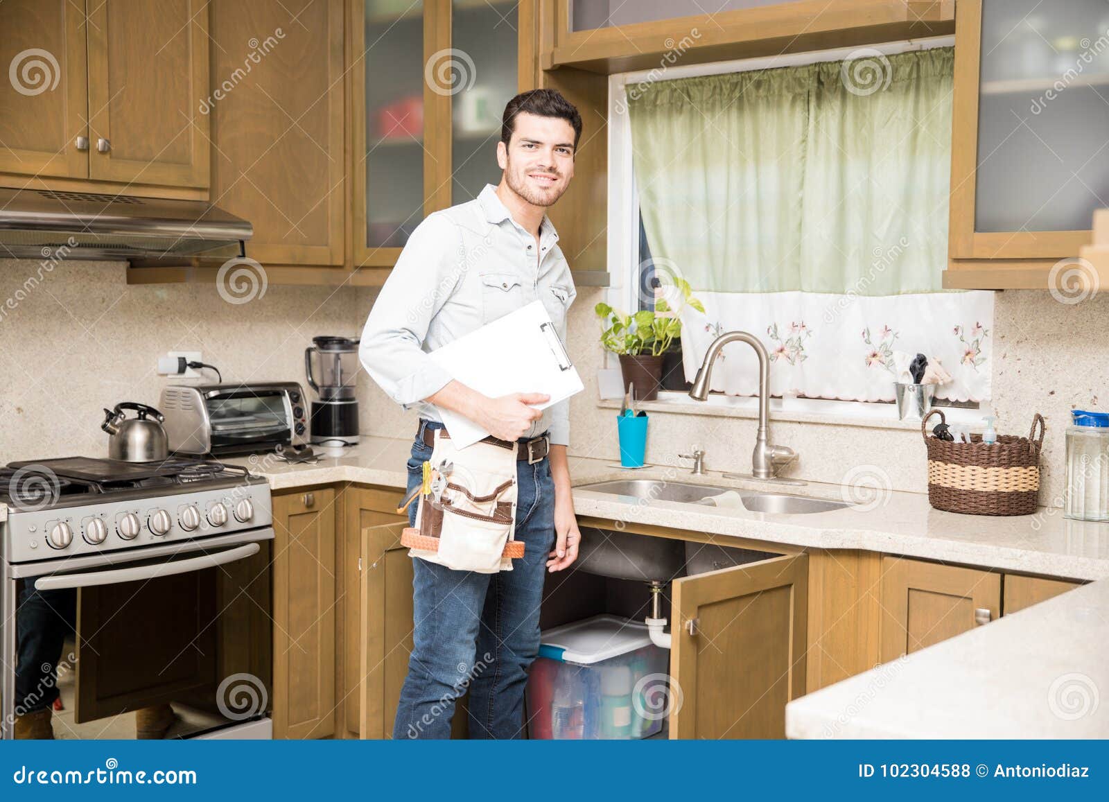 Handyman Doing Some Work in a Kitchen Stock Photo - Image of repair ...