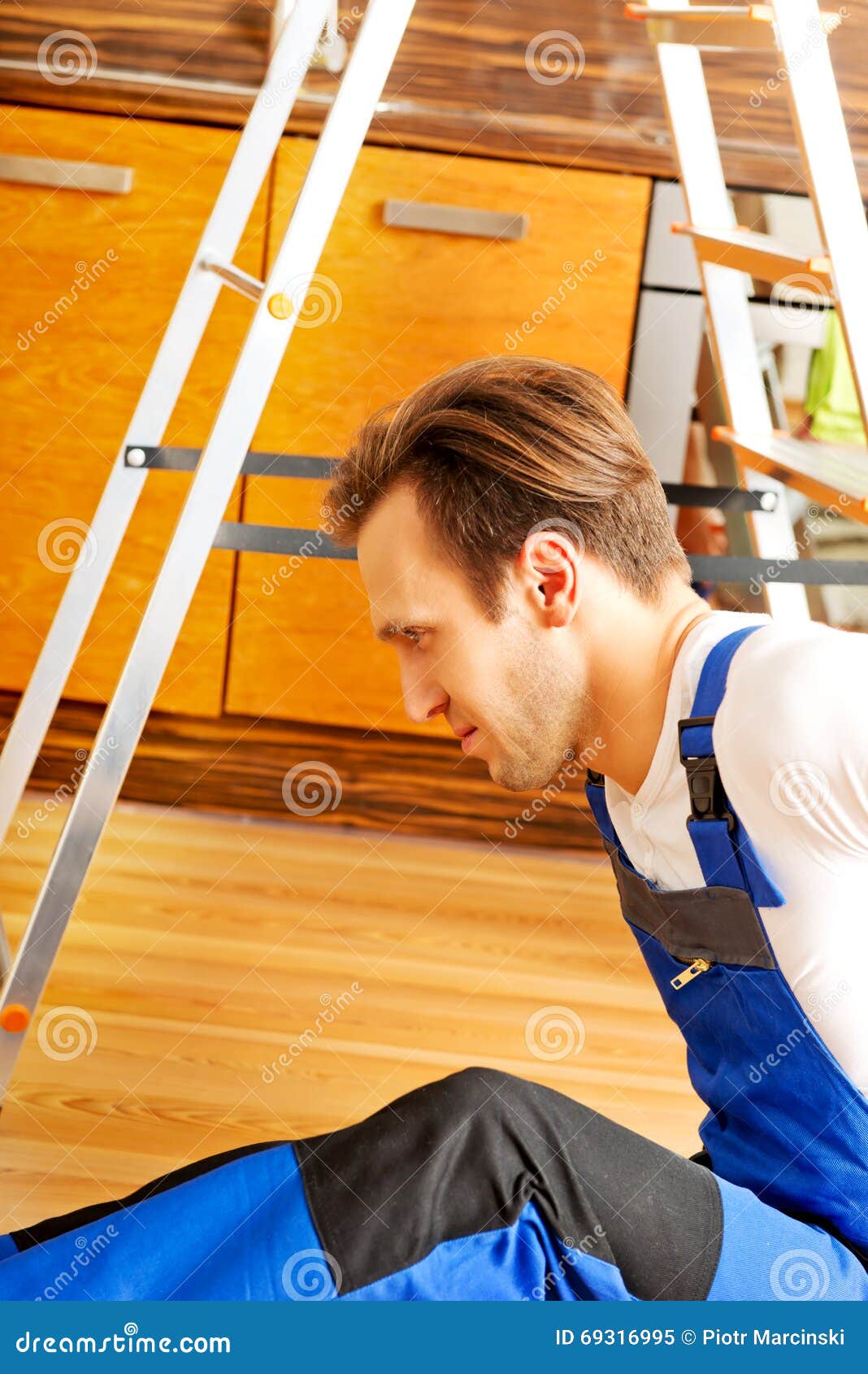 Handyman Fell from a Ladder and Sitting on the Floor with Backache ...