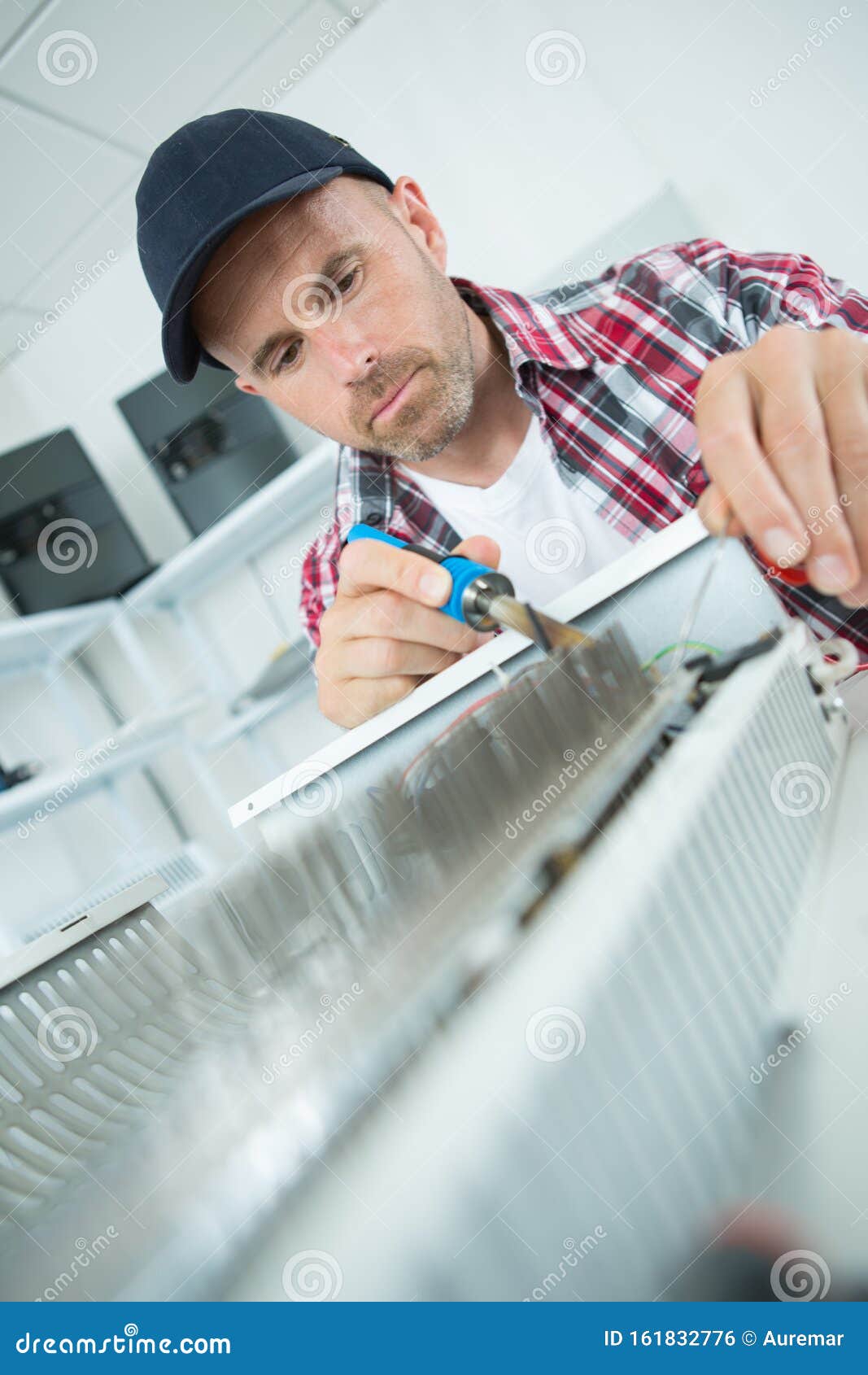 Handyman fixing radiator stock photo. Image of heat - 161832776