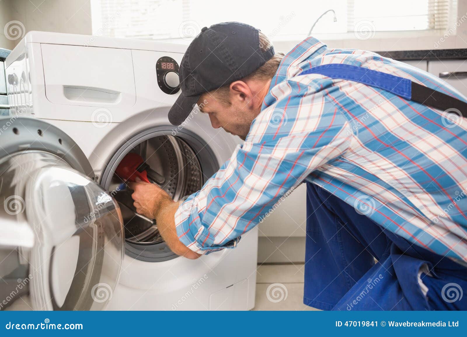 Handyman Fixing a Washing Machine Stock Image - Image of repair ...