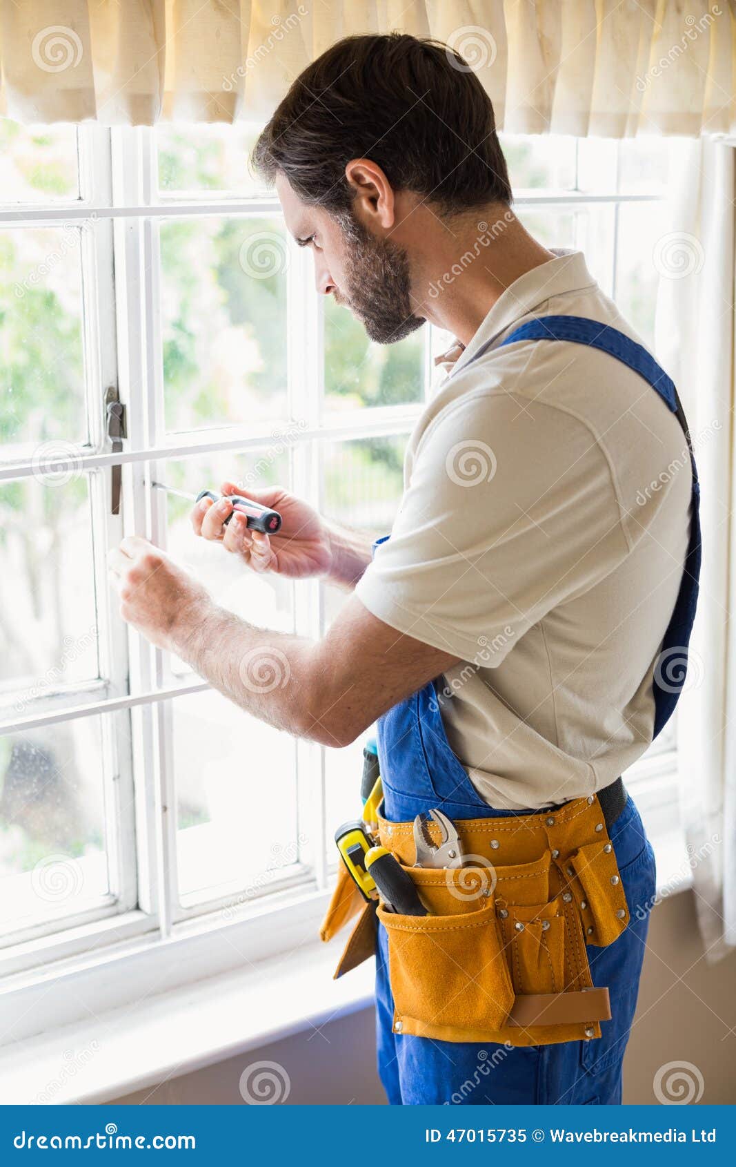 Handyman fixing a window stock image. Image of wear, male - 47015735