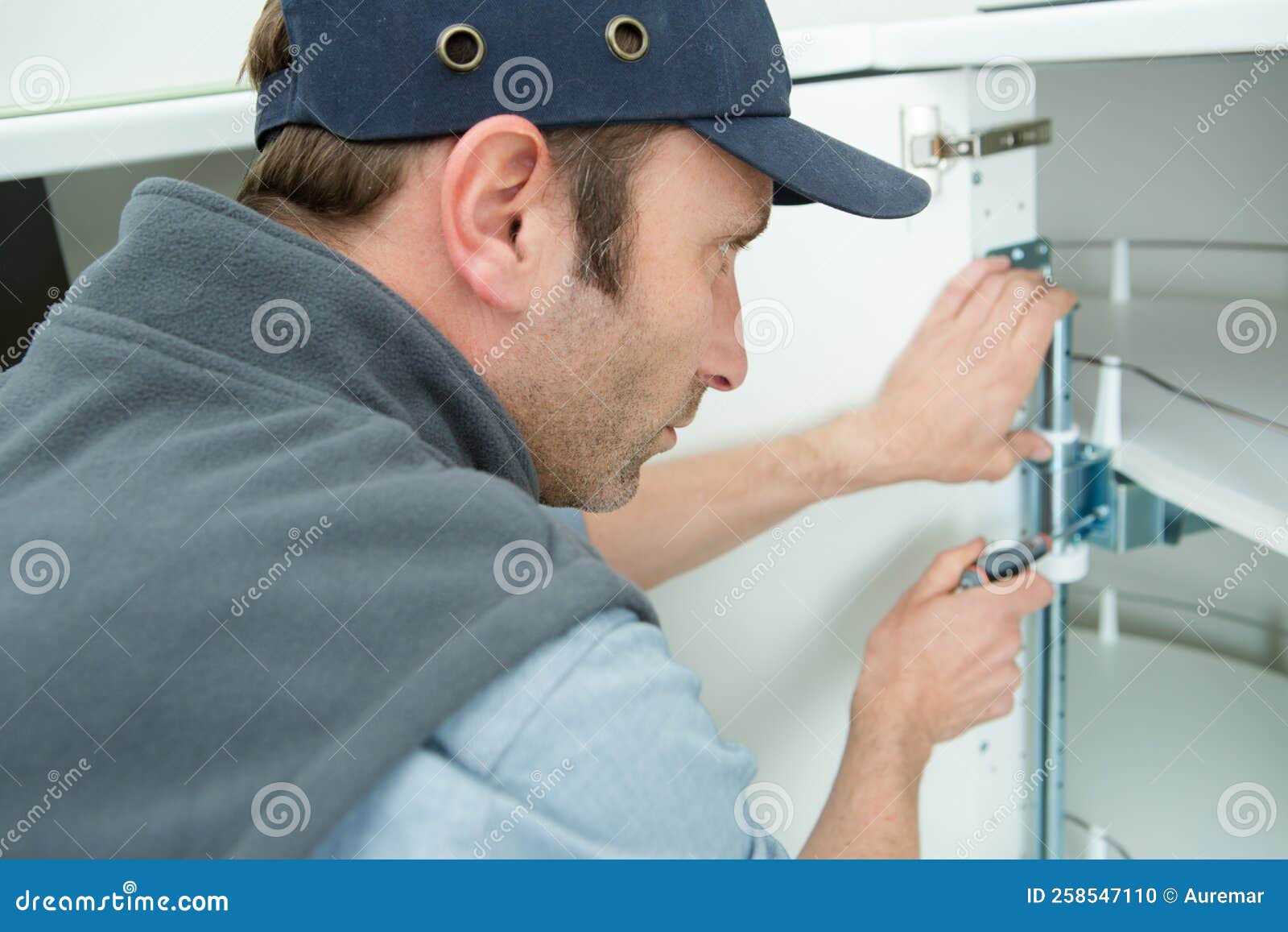Handyman Installing Corner Fitting Cupboard Stock Photo - Image of ...