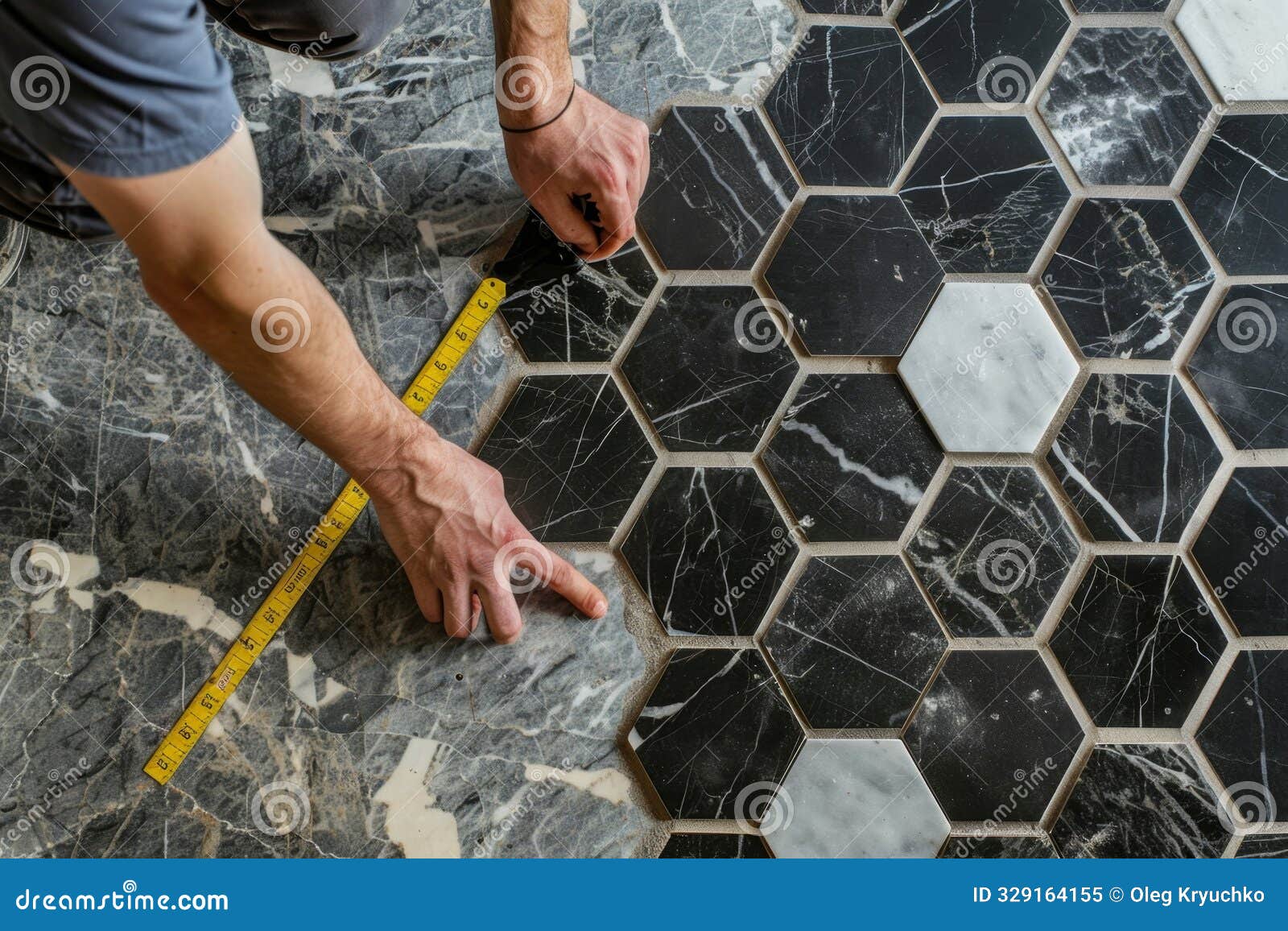 Handyman Measuring Black Marble Hexagonal Tiles on the Floor. Tools are ...