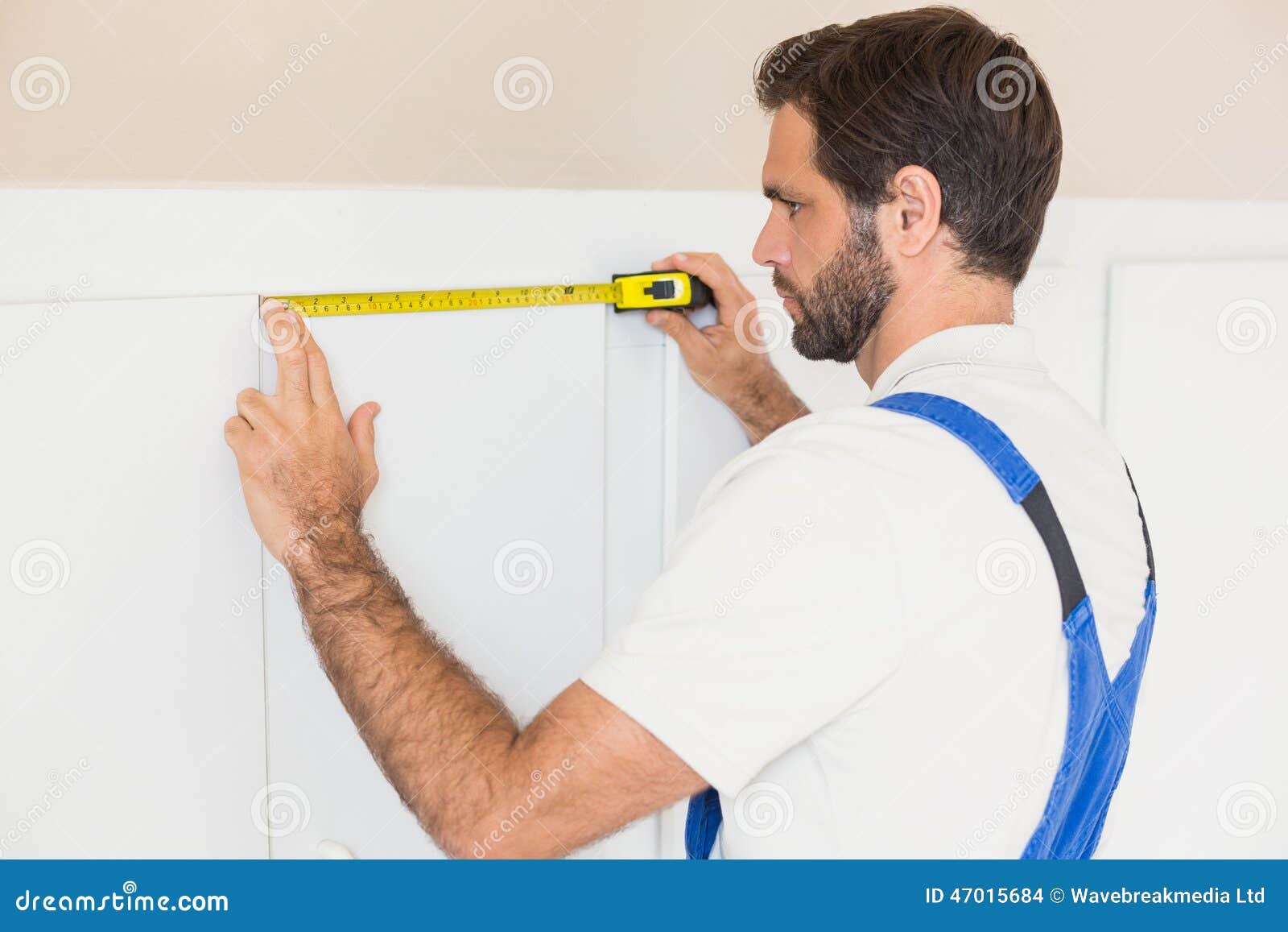 Handyman Measuring a Wardrobe Stock Photo - Image of person, occupation ...