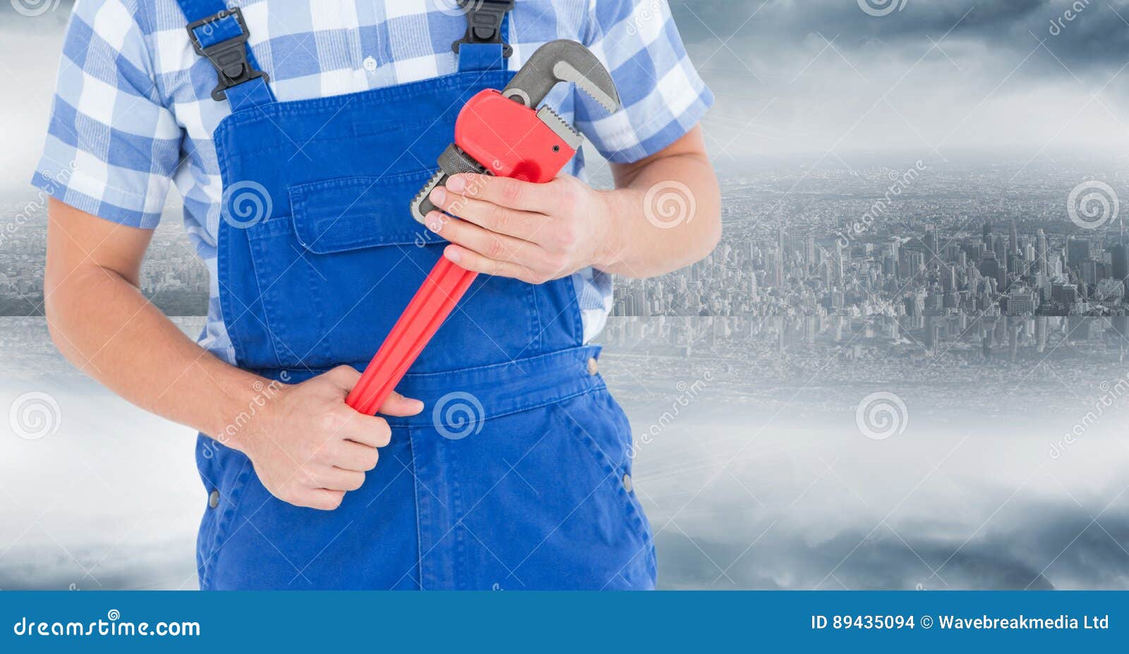Handyman with Red Wrench Against Blurry Skyline Stock Photo - Image of ...