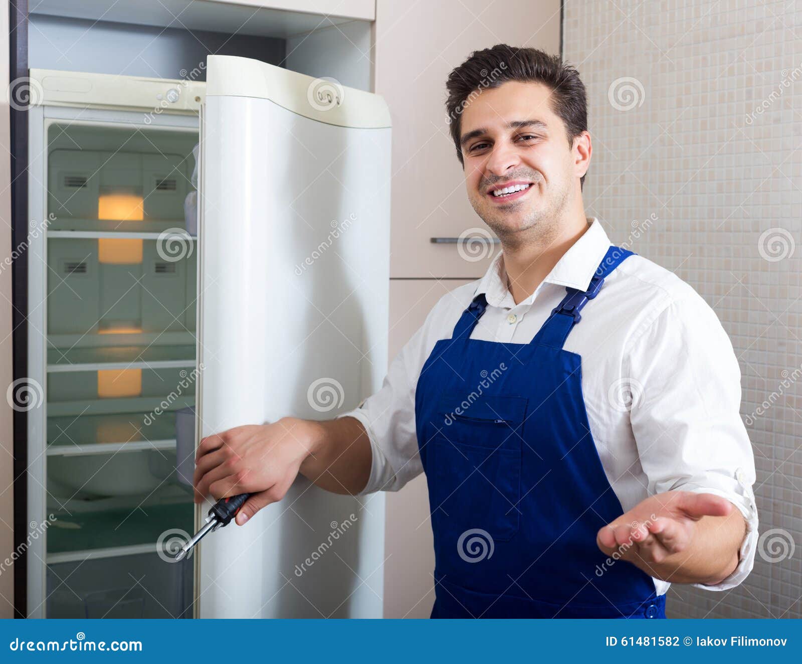 Handyman Repairing Refrigerator in Kitchen Stock Photo - Image of happy ...