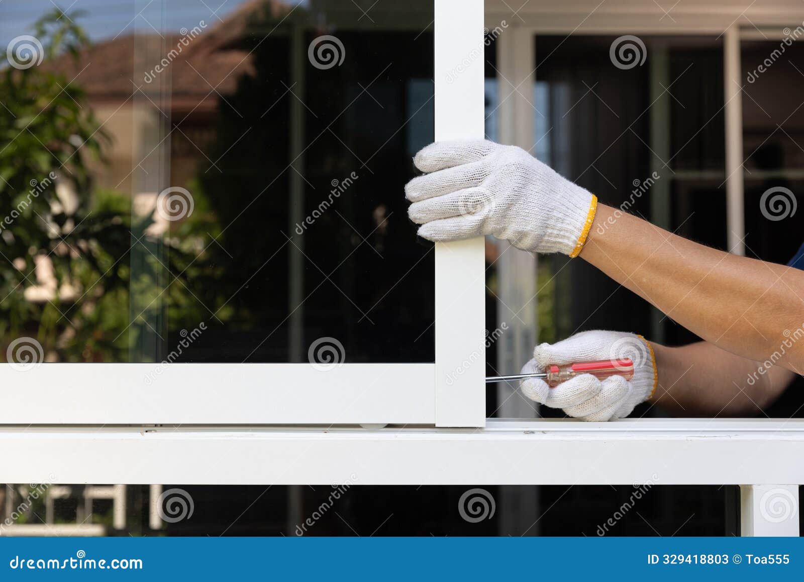 Handyman Repairing the Sliding Window. Adjust a Rail Wheel and Lock ...