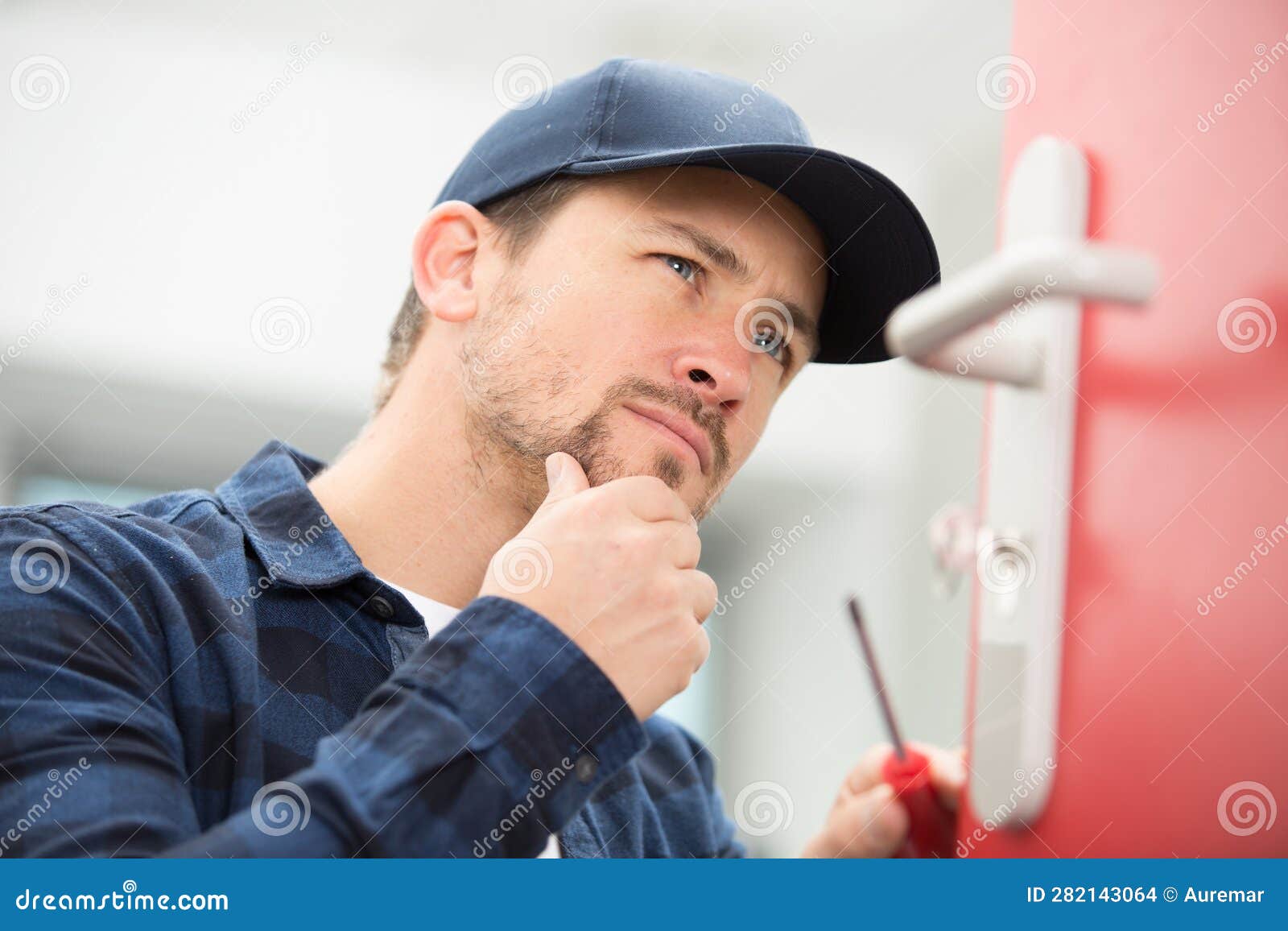 Handyman with Screwdriver Examining Door Stock Photo - Image of career ...