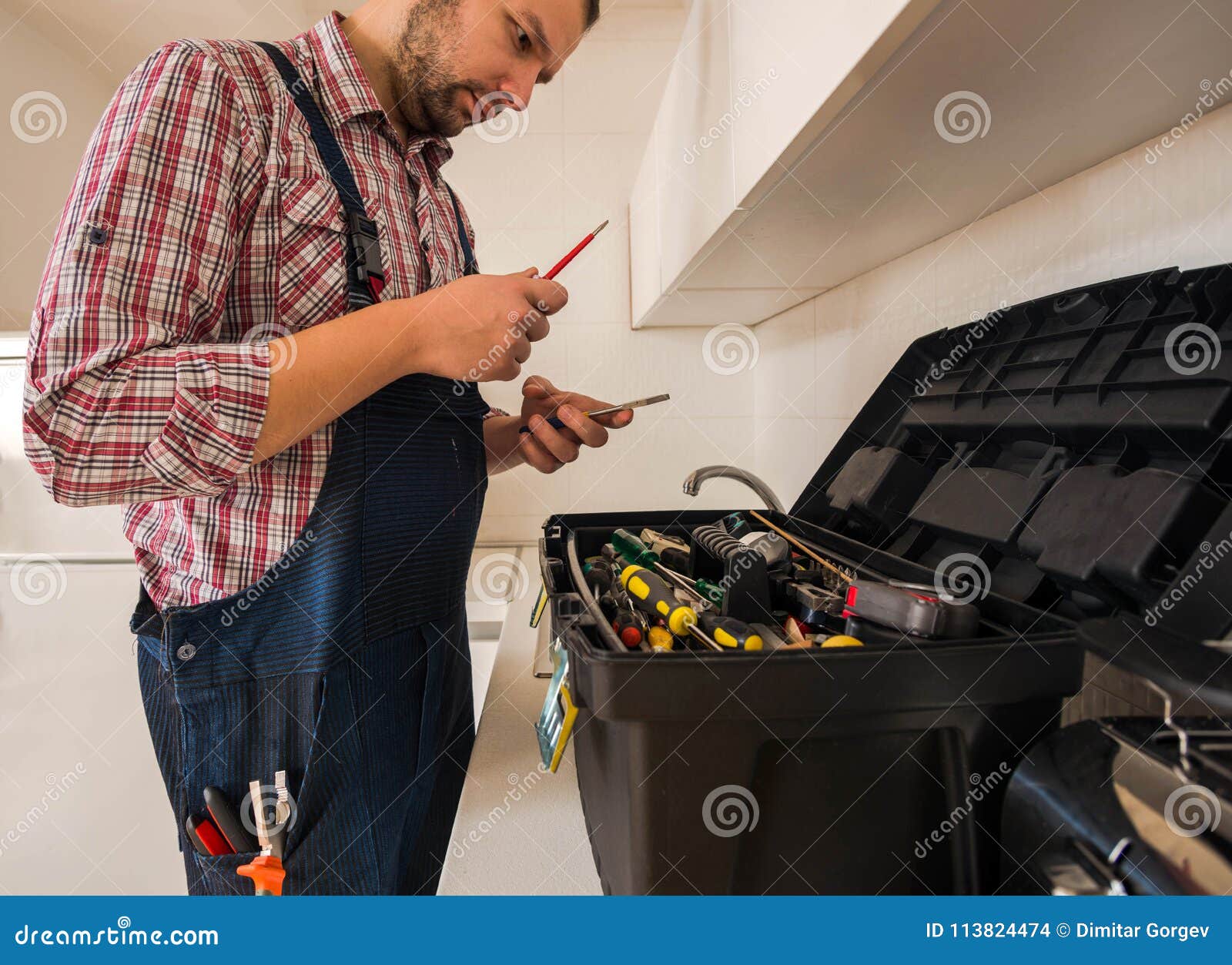 Handsome Guy Searching His Tool in the Kitchen Stock Photo - Image of ...