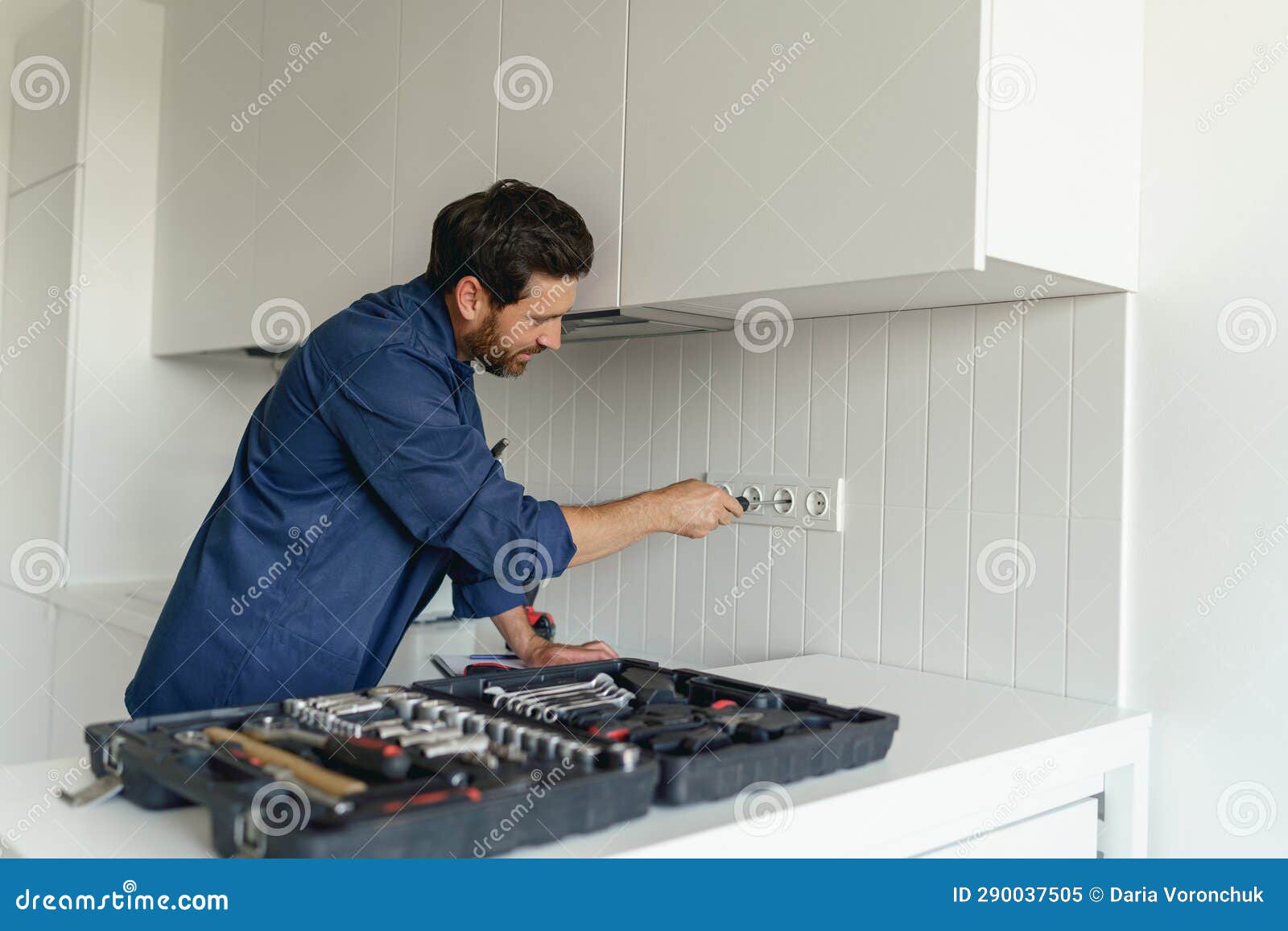 Professional Electrician Using Screwdriver while Installing New ...