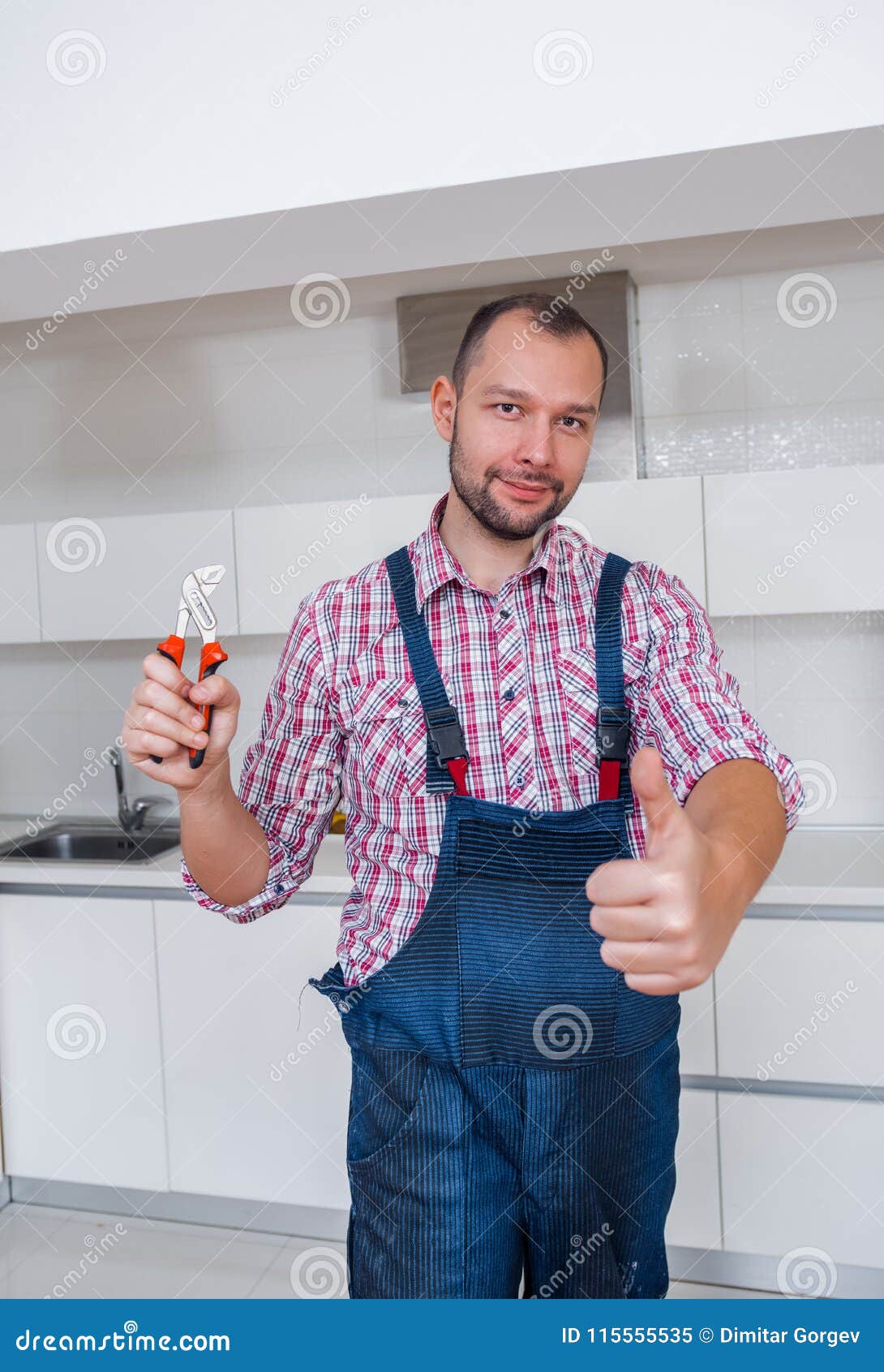 Handyman in Uniform Standing Next To the Toolbox in the Kitchen Stock ...