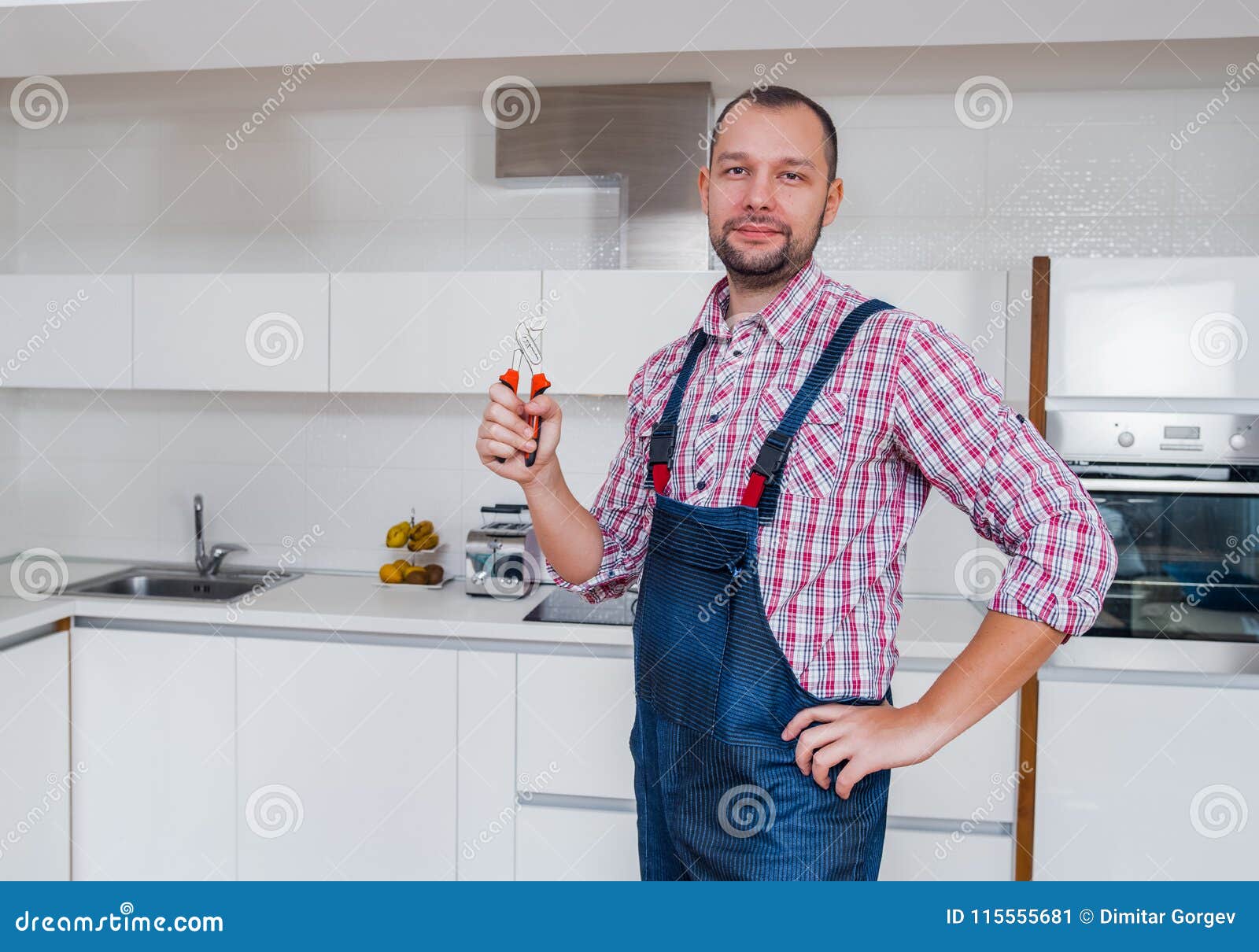 Handyman in Uniform Standing Next To the Toolbox in the Kitchen Stock ...