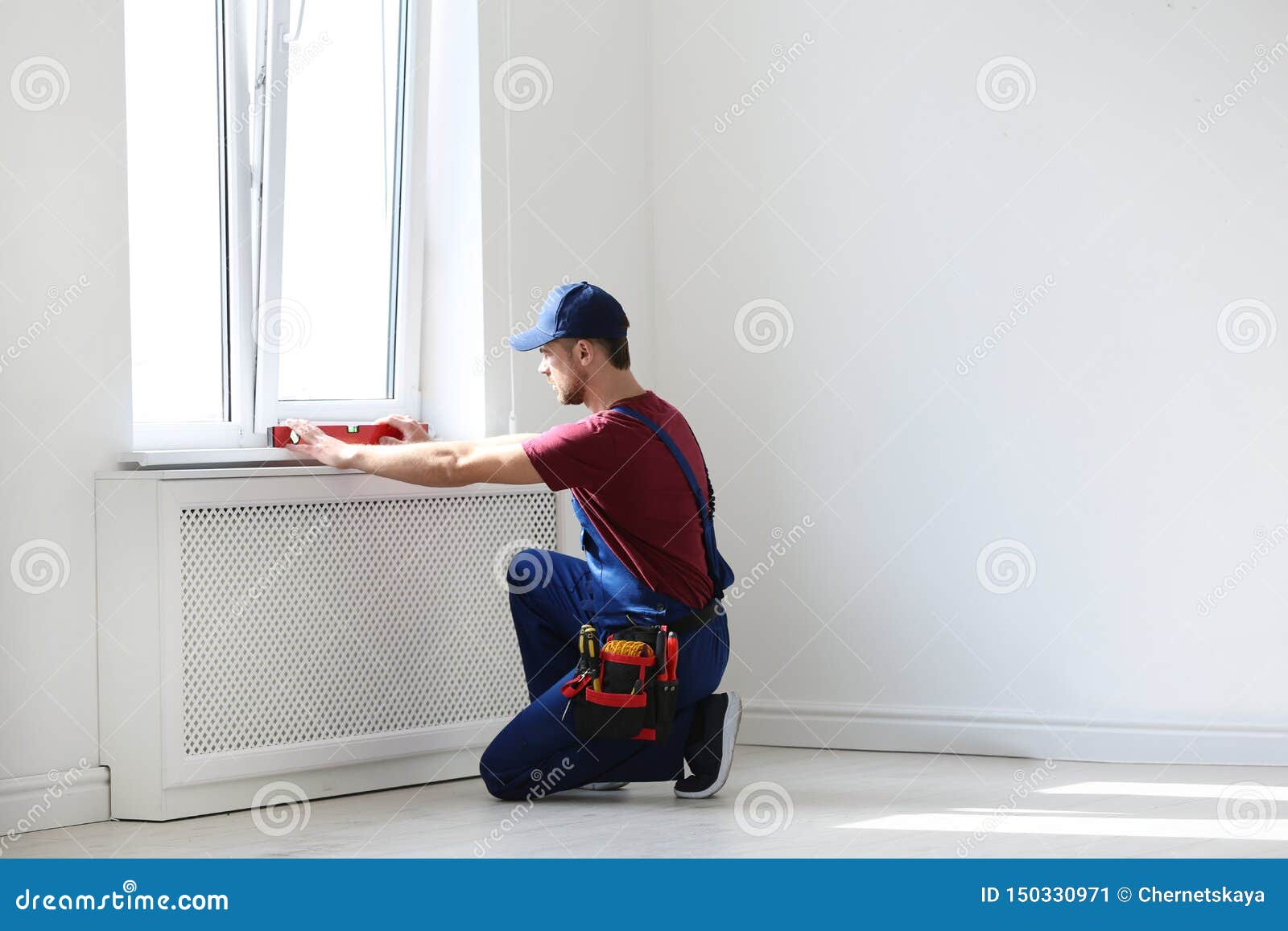 Handyman in Uniform Working with Building Level. Professional ...