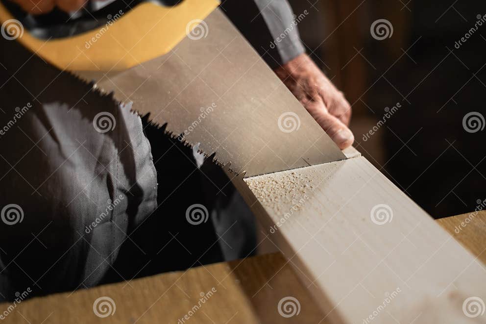 Handyman Using Hand Saw. Handyman with Saw in Workshop Stock Photo ...