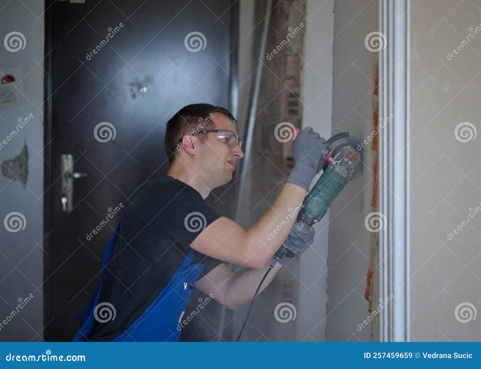Handyman using machine stock image. Image of builder - 257459659