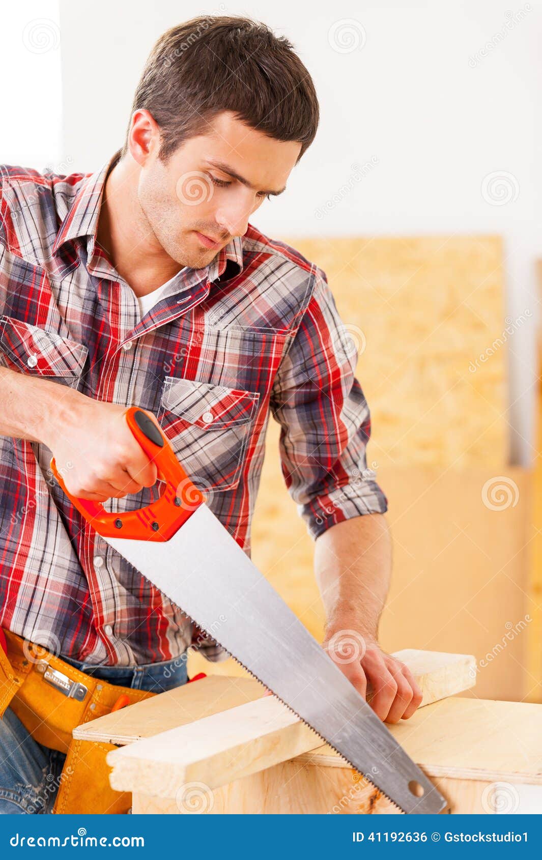 Handyman using saw. stock photo. Image of expression - 41192636