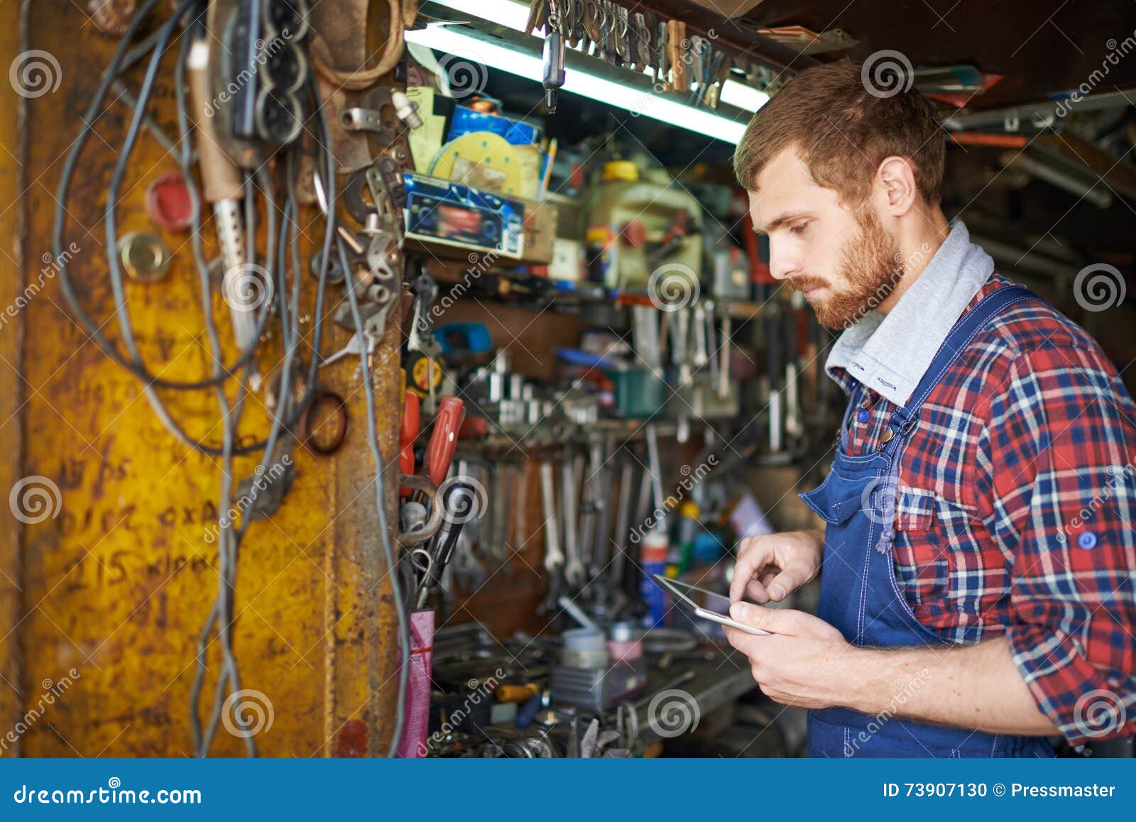 Handyman at work stock photo. Image of uniform, engineer - 73907130