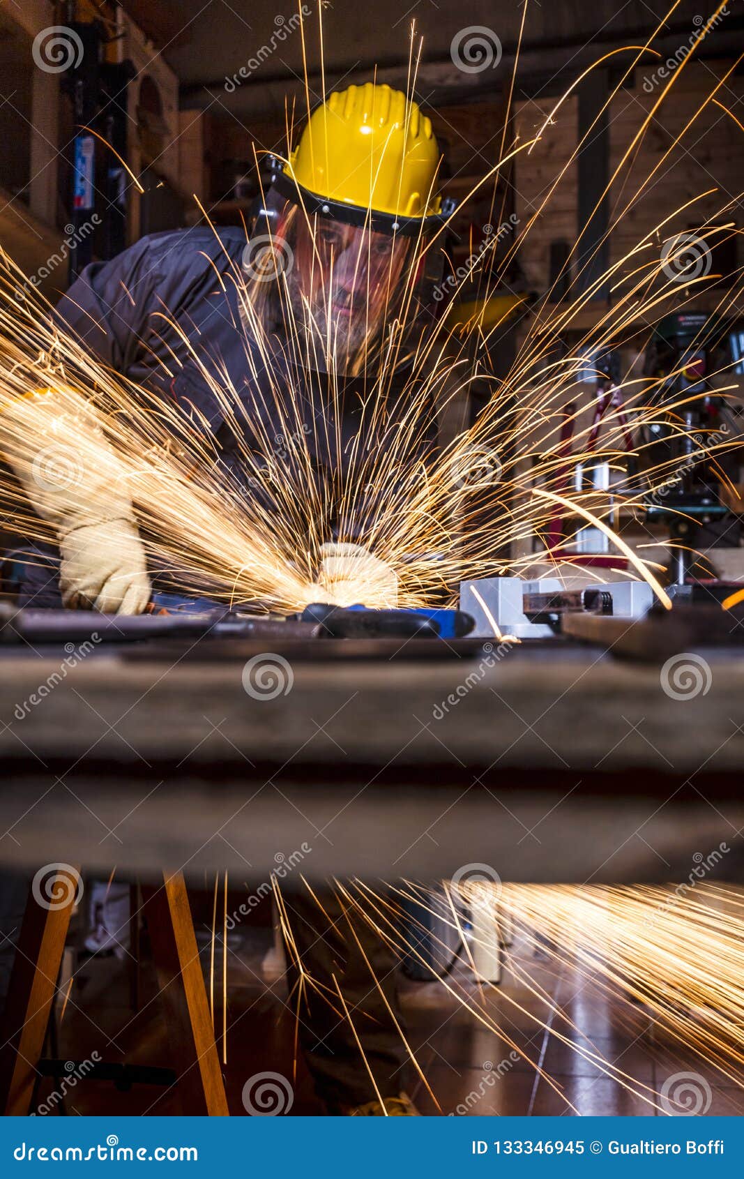 Man with grinder in action stock image. Image of equipment - 133346945