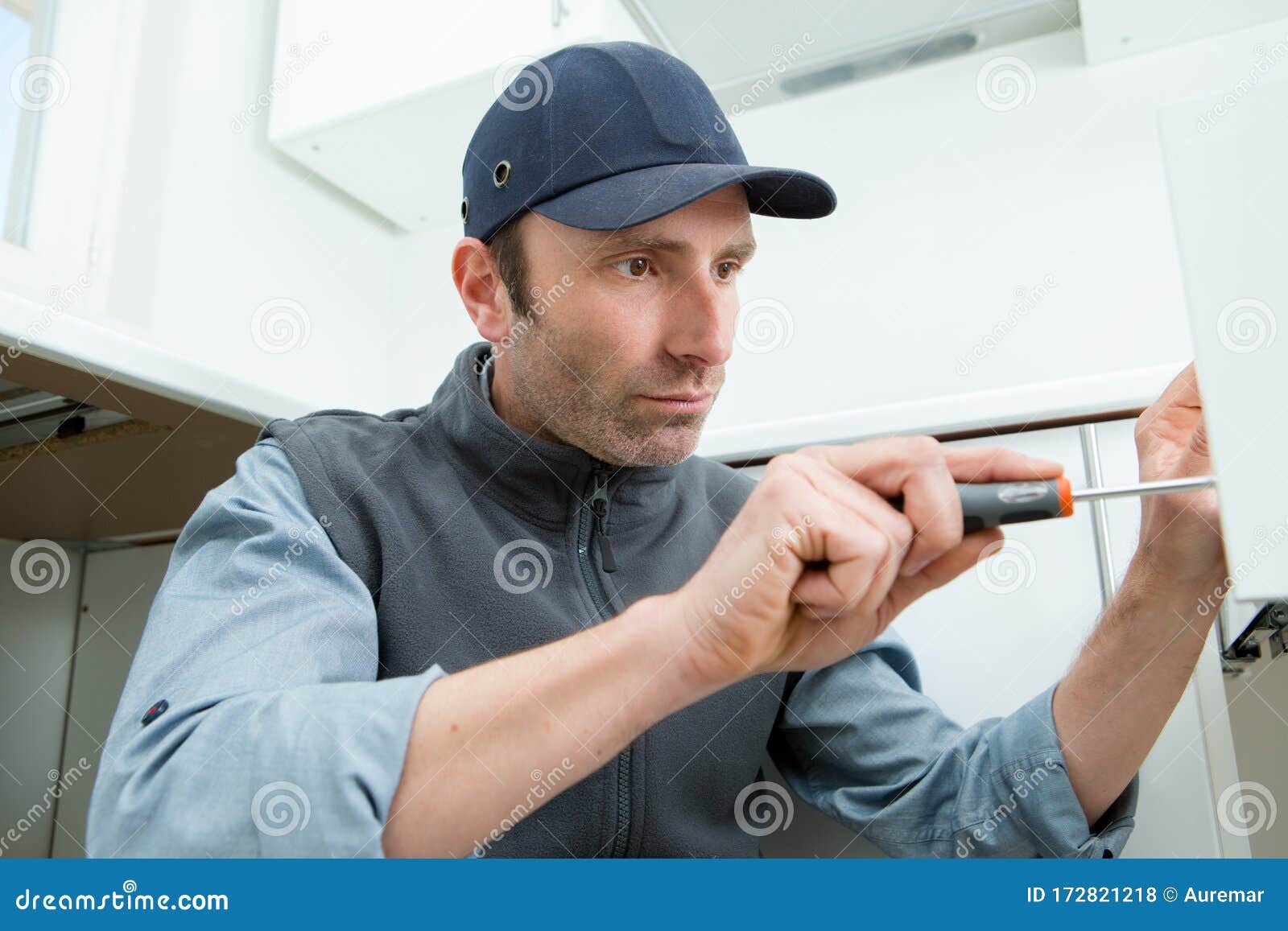 Handyman Working in Kitchen Using Screwdriver Stock Photo - Image of ...