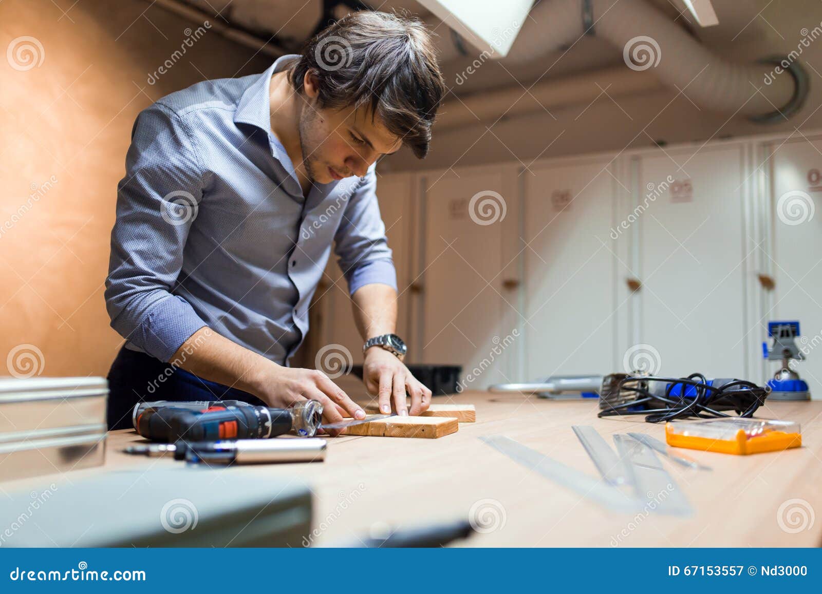 Handyman working with wood stock image. Image of measurement - 67153557