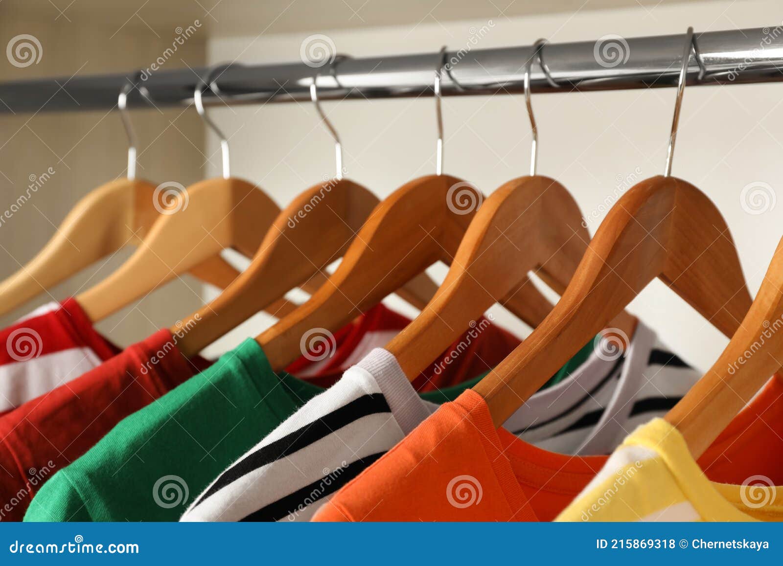 Hangers with Bright Clothes on Rack in Wardrobe, Closeup Stock Photo ...