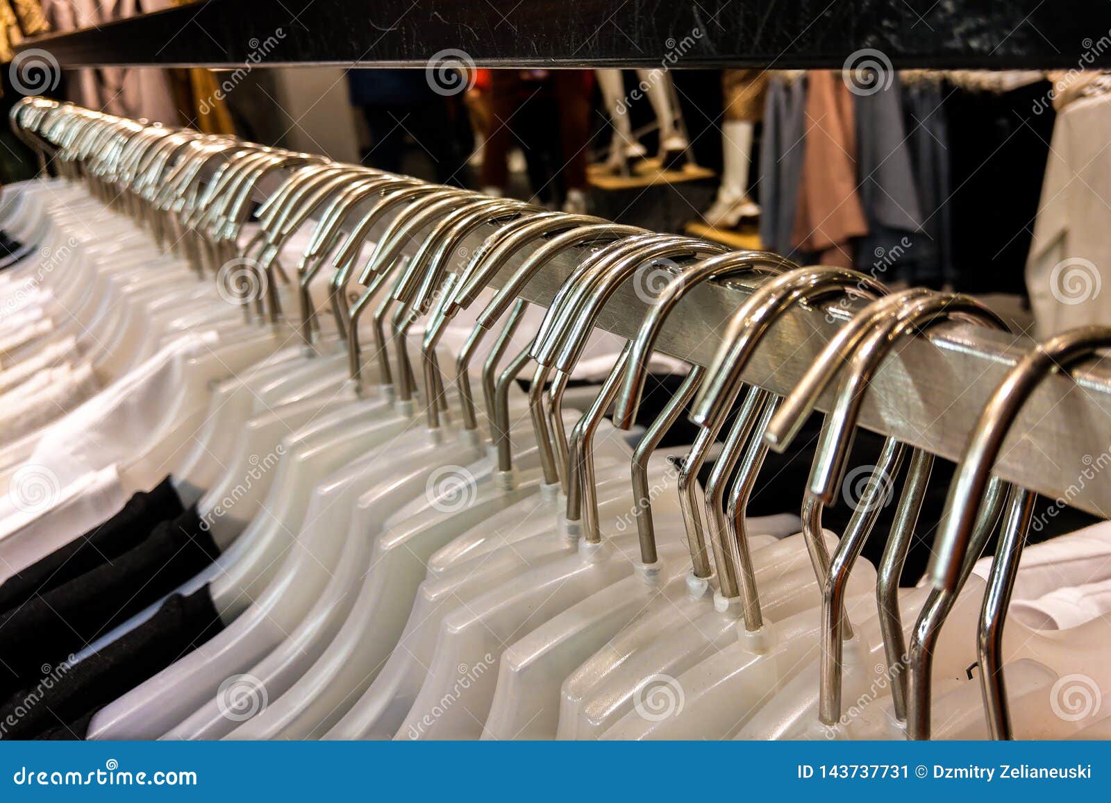Hangers with Clothes in a Row in the Store. Things on Hangers Stock ...