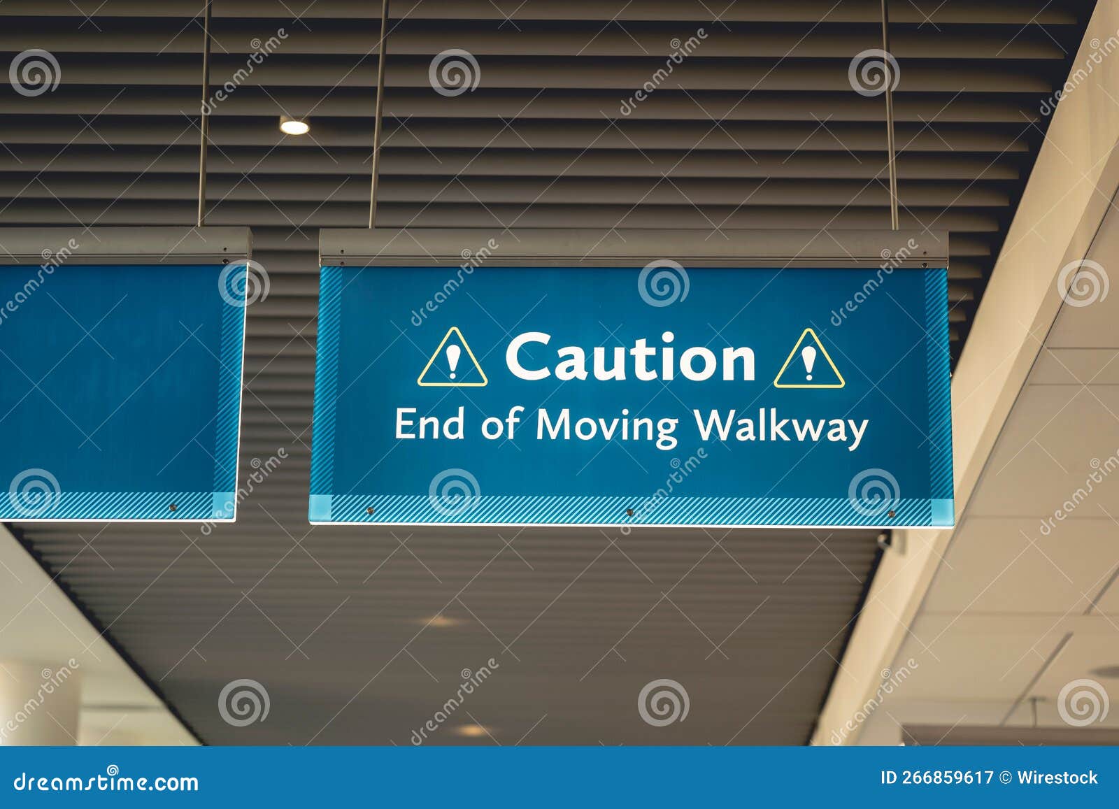 Hanging Blue Cation Sign Warning the End of a Moving Walkway Stock ...
