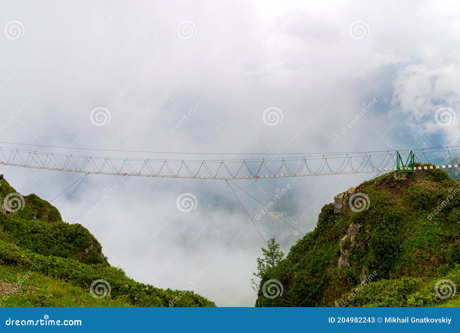 Hanging Bridge Over Chasm in Fog. Rope Bridge between Peaks in Cloud ...