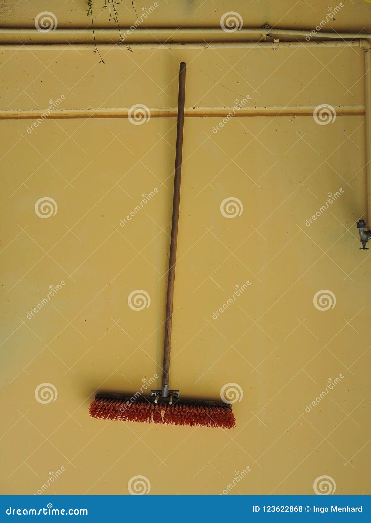 Hanging broom on the wall stock photo. Image of people - 123622868