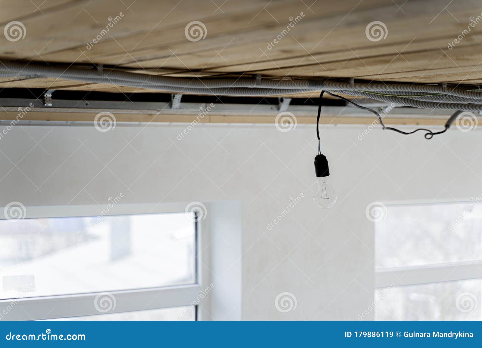 Hanging a Light Bulb in a Building Under Construction Stock Image ...