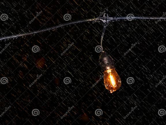 Hanging Light Bulb Glows Under the Strong Rain Stock Image - Image of ...