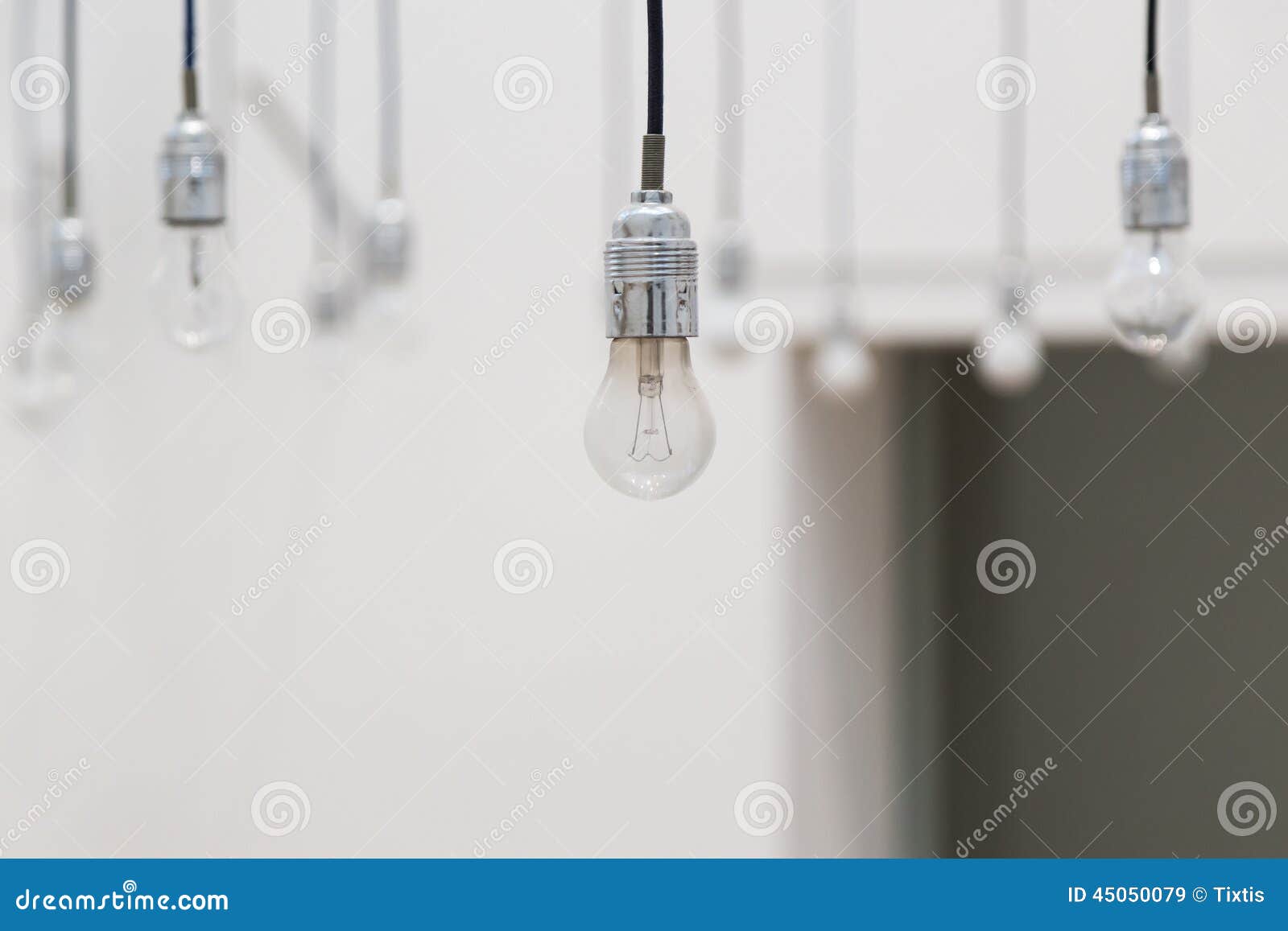 Hanging Light Bulbs On Blurred Background Stock Image - Image of ...