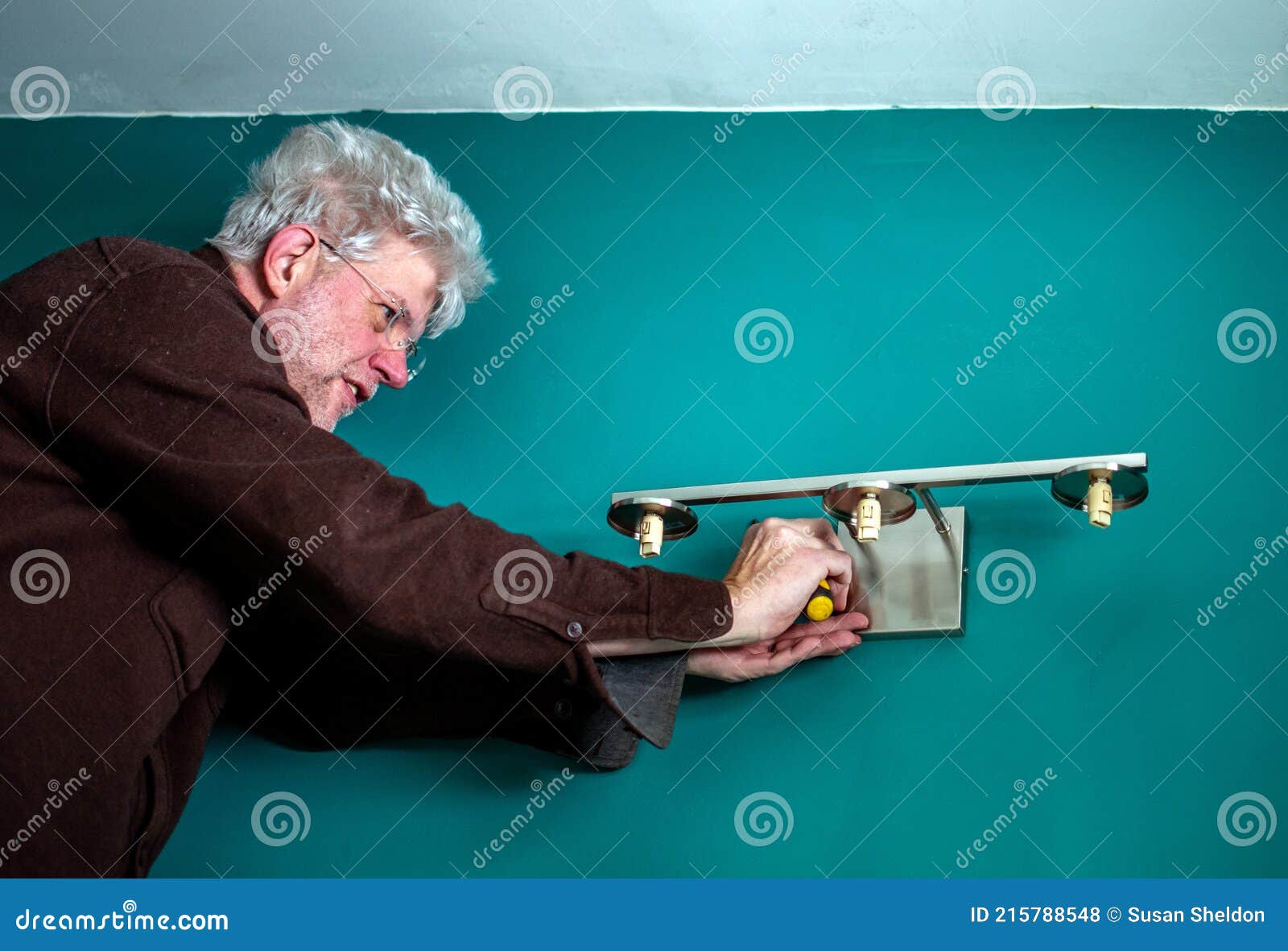 Man Hanging a Light Fixture Stock Photo - Image of install, floodlight ...