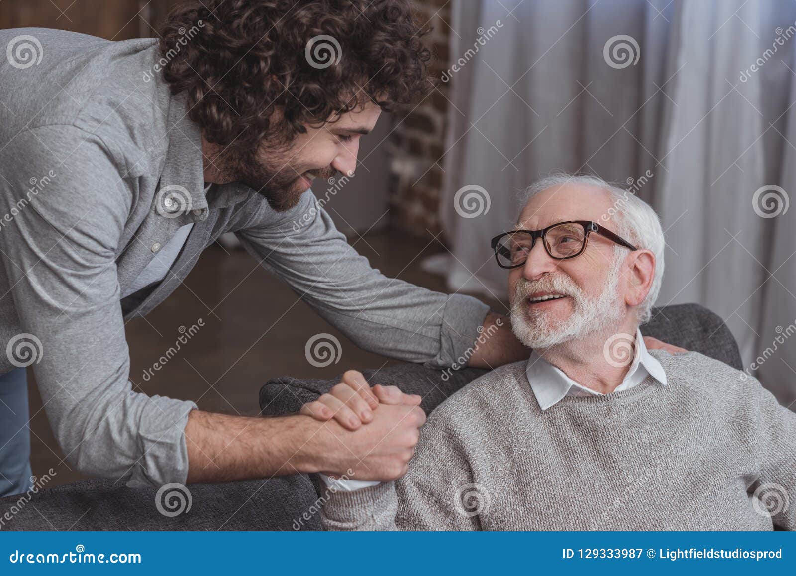 Happy Adult Son And Senior Father Shaking Hands Stock Image Image Of