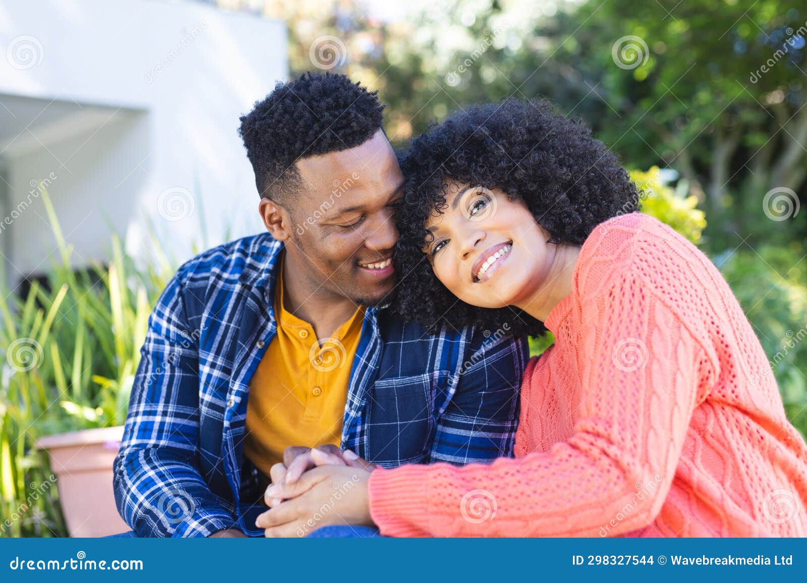 Happy African American Couple Embracing And Holding Hands On Stairs In