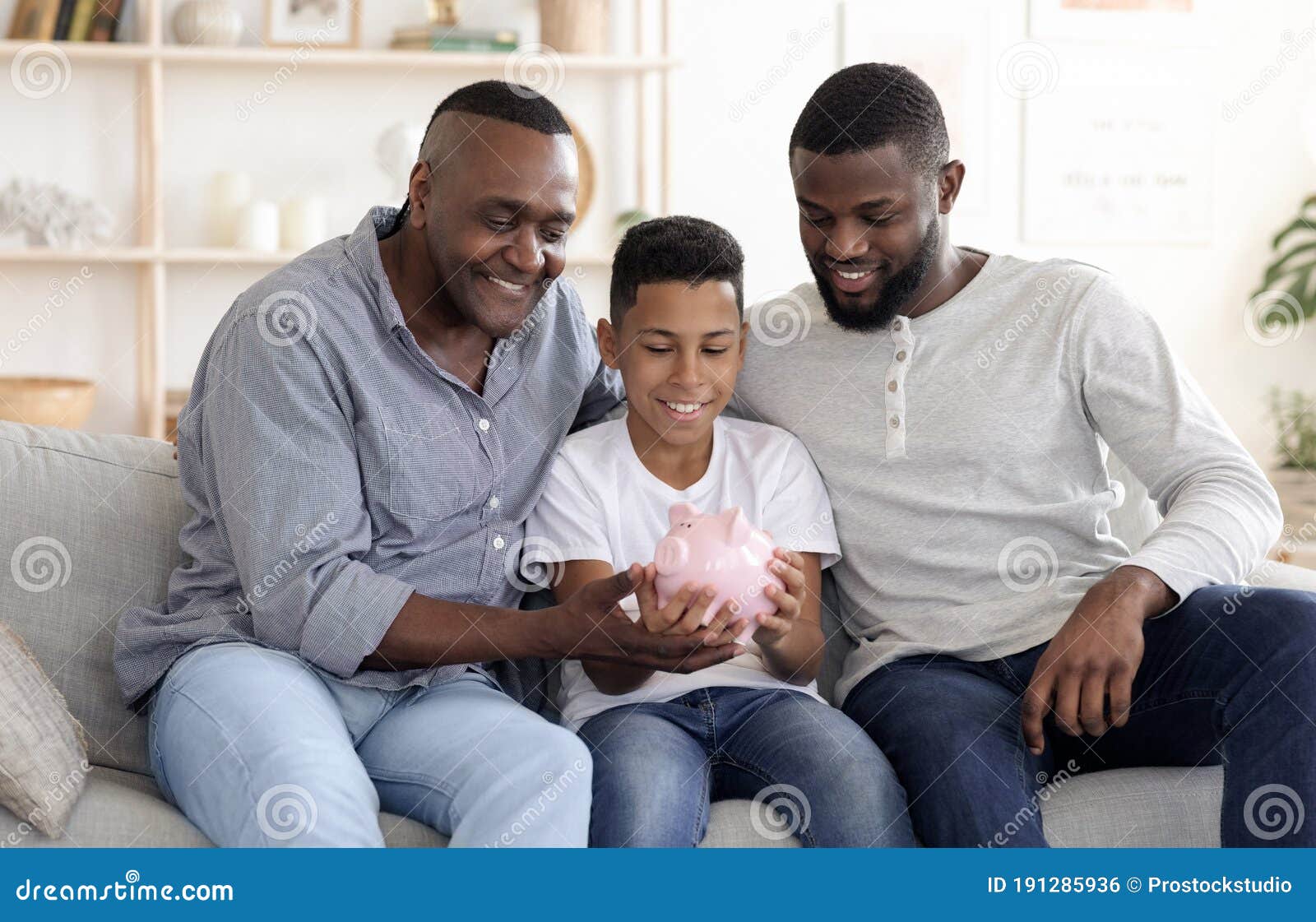 Happy African American Father Son And Grandpa Sitting On Couch With