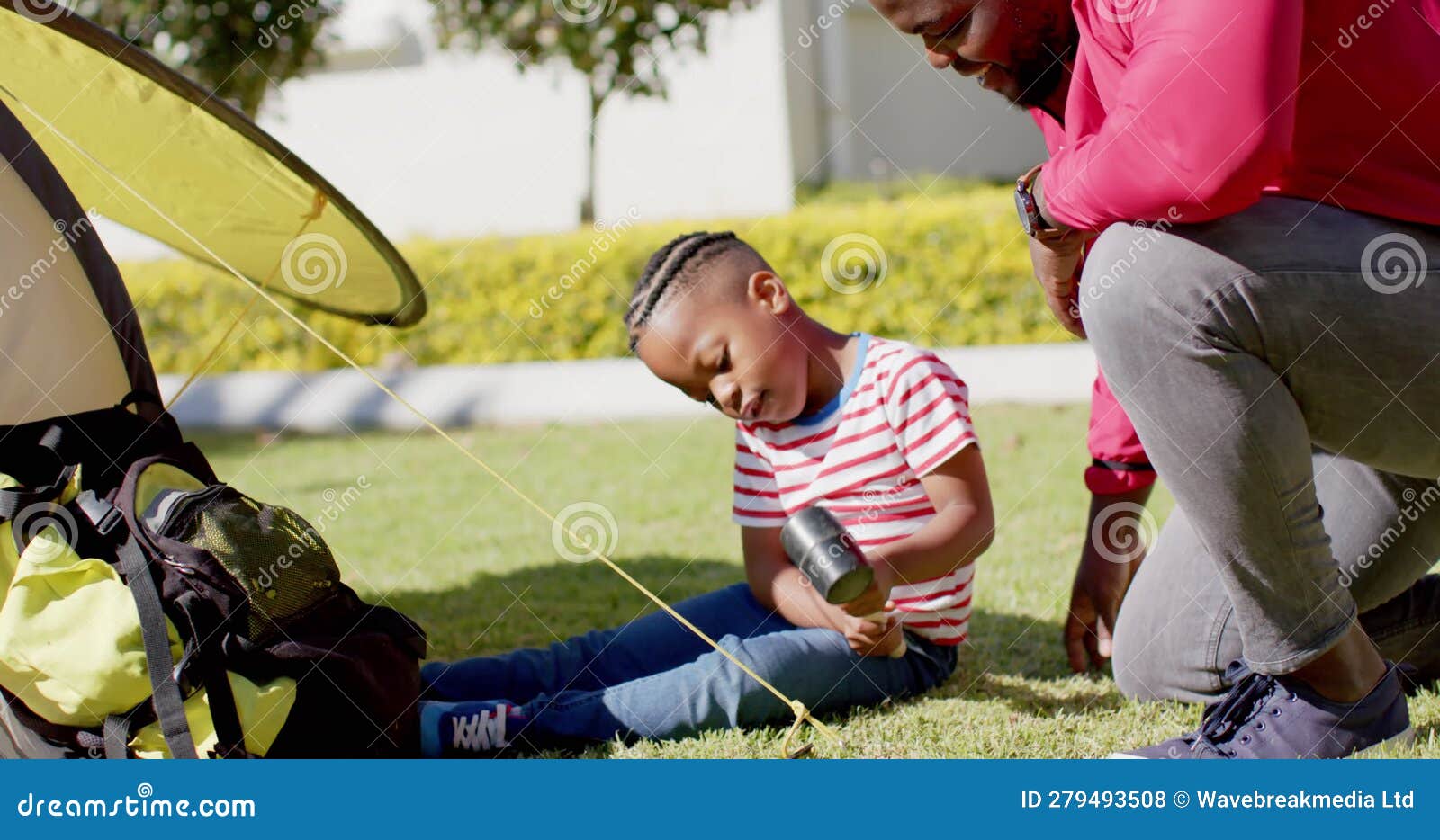 Happy African American Father And Son Pitching Tent Together In Sunny