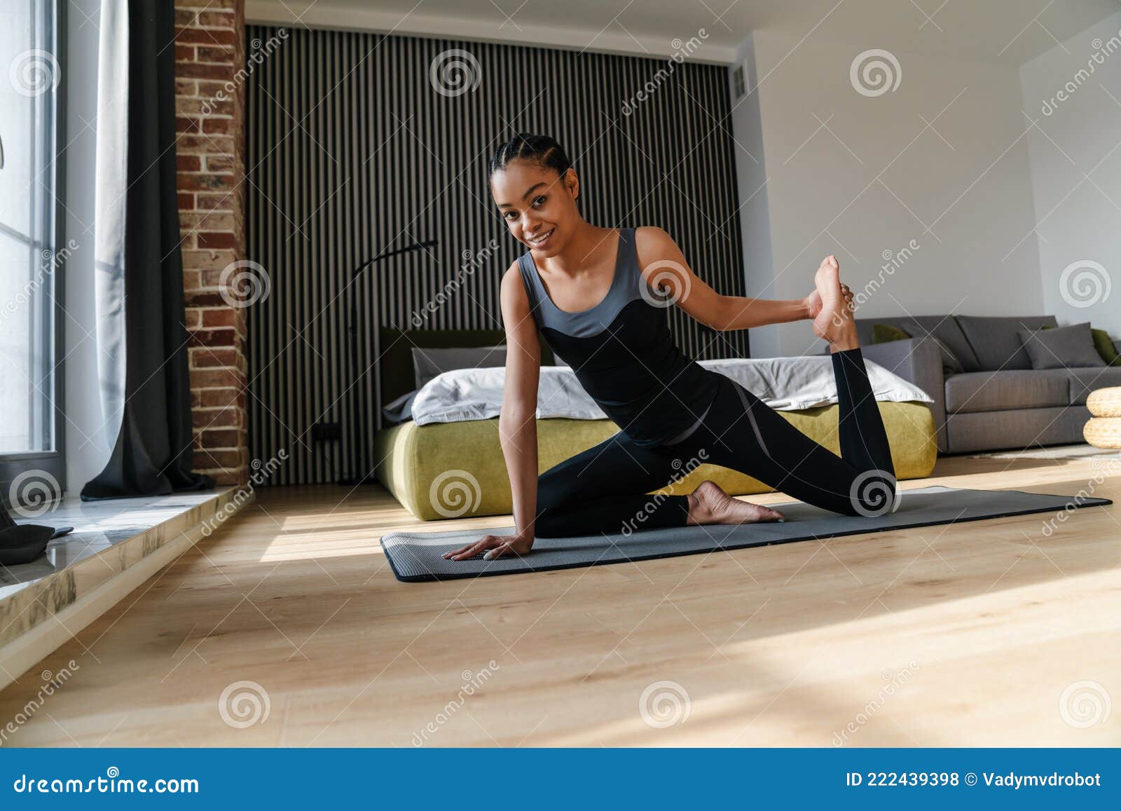 Happy African American Girl Stretching Her Leg While Doing Yoga