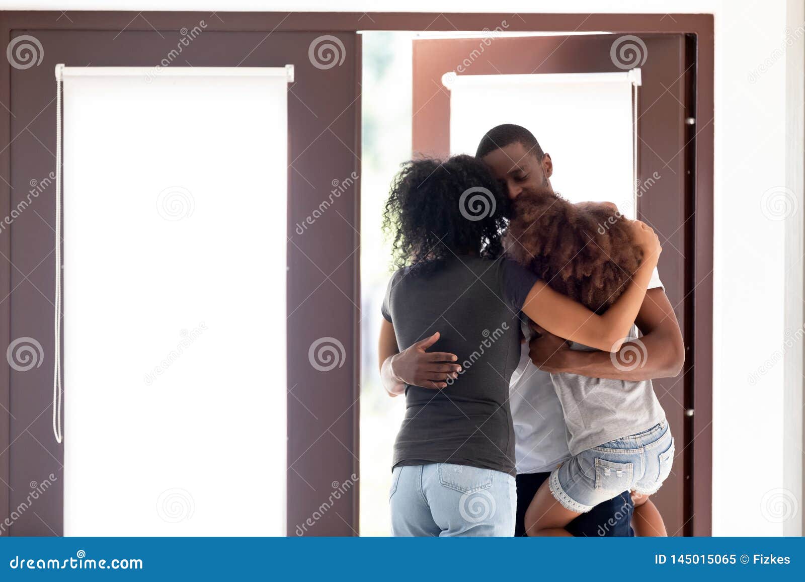 Happy African American Man Arrived Home, Family Embracing Stock Image ... Happy African American Man Arrived Home, Family Embracing Stock Image ...