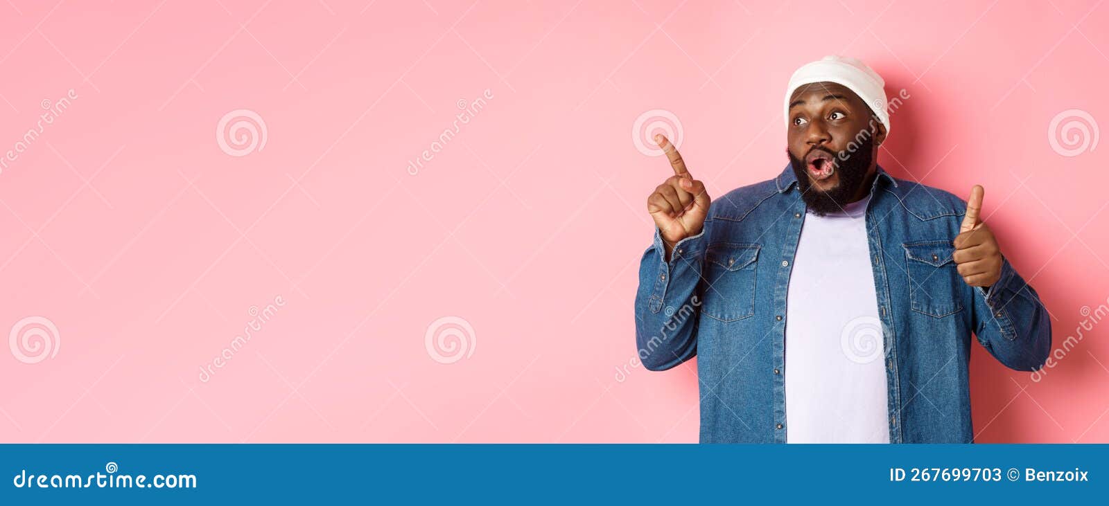 Happy African American Man Showing Thumb Up And Pointing At Upper Left